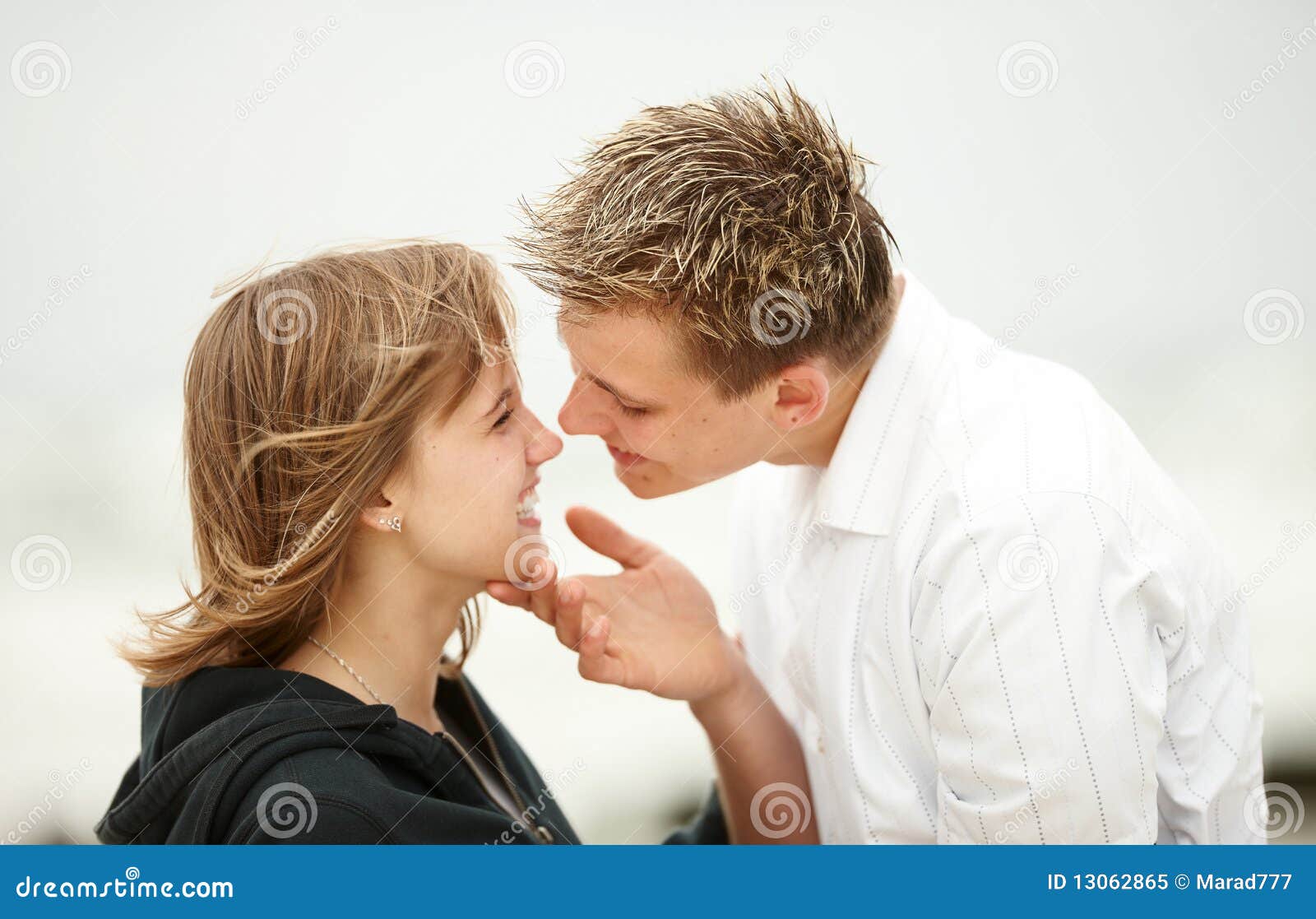 Young Couple Kissing on Beach Stock Image - Image of angle, adults ...