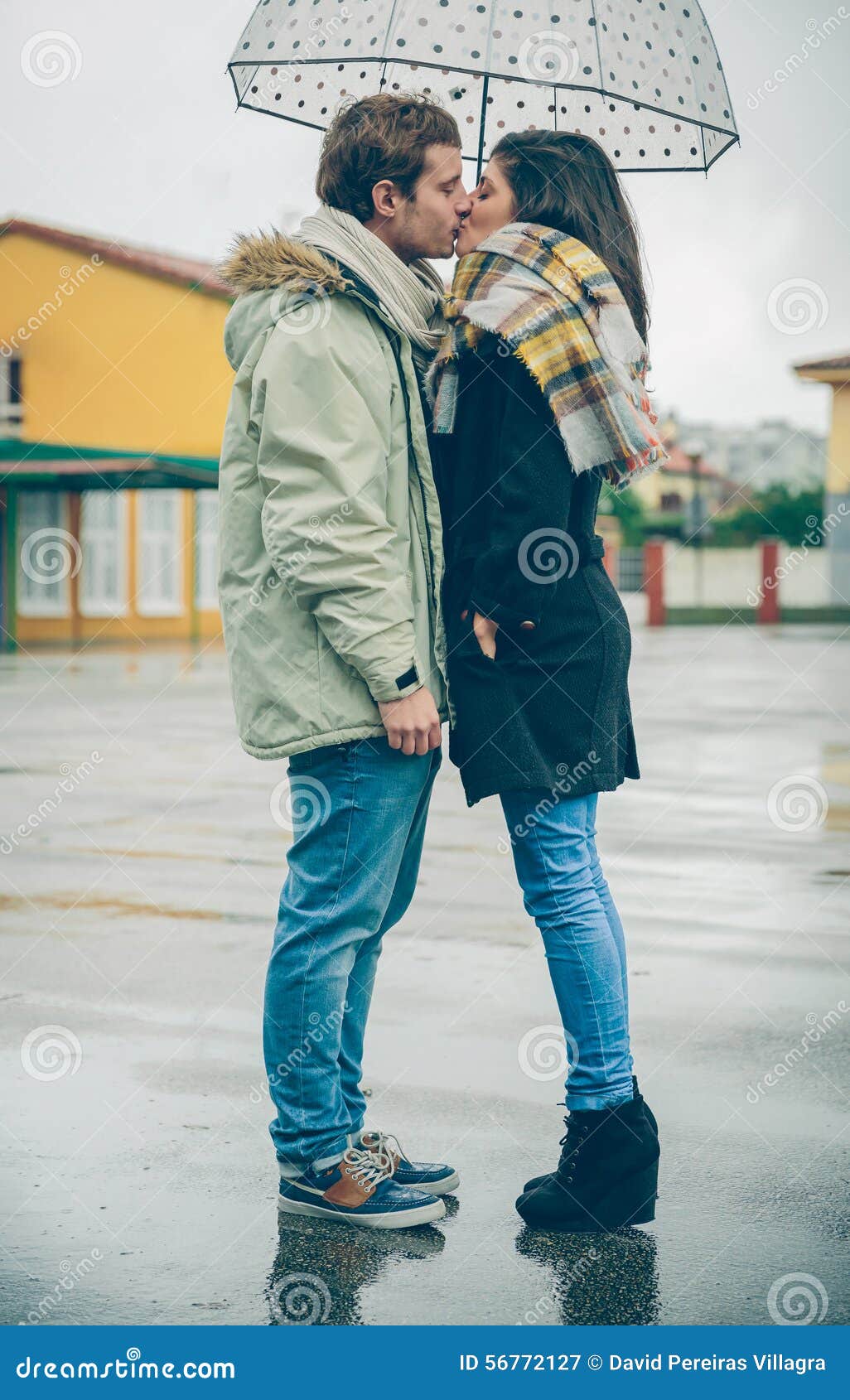 Young Couple Kissing Outdoors Under Umbrella In A Stock Image Image