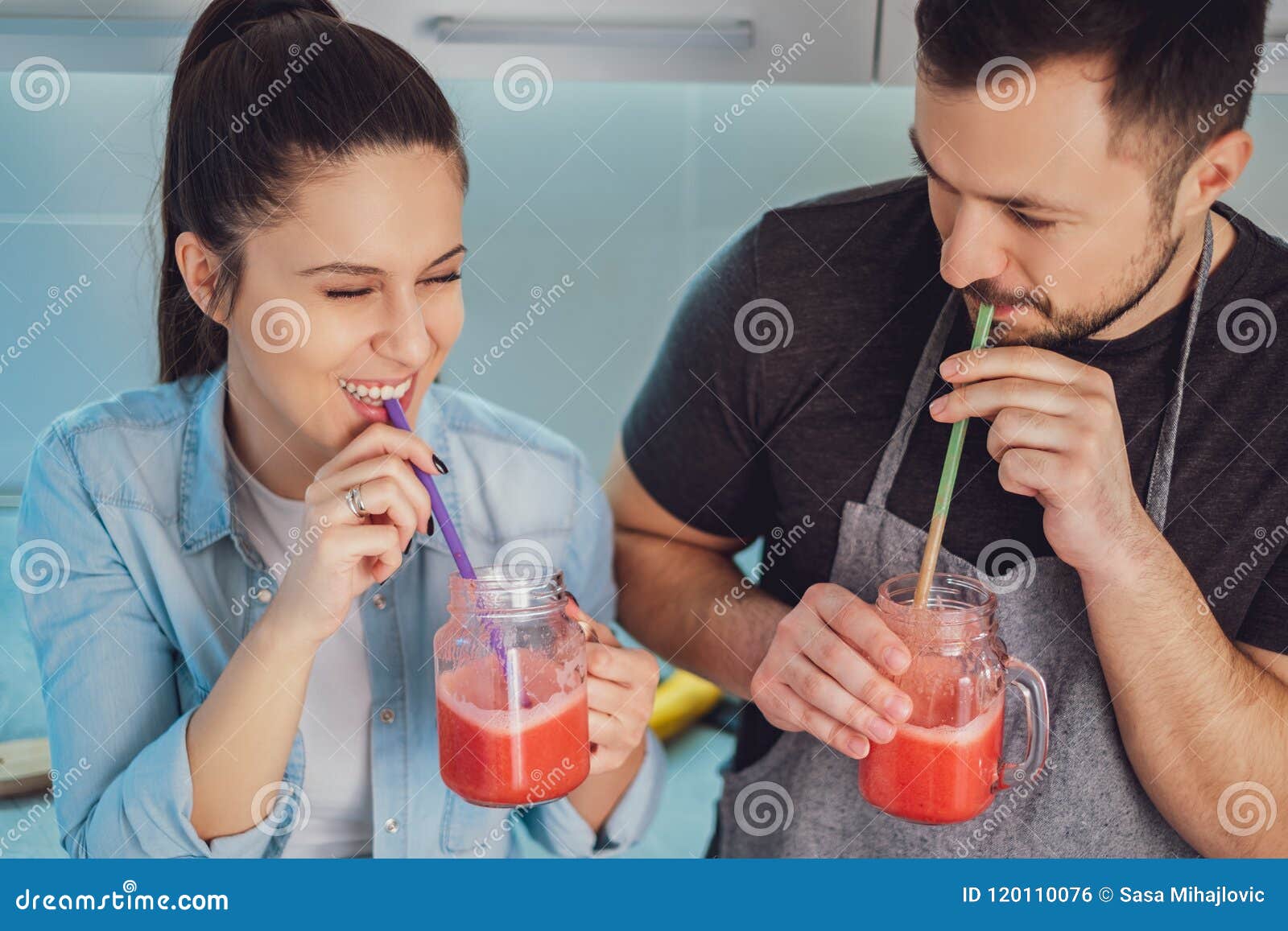 Couple Laughing while Drinking Smoothie in the Kitchen Stock Photo ...