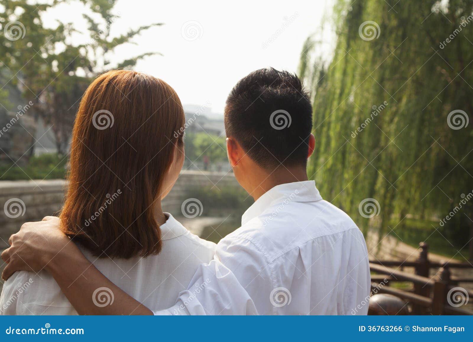 Young Couple Looking Downstream Stock Photo - Image of falling, casual ...