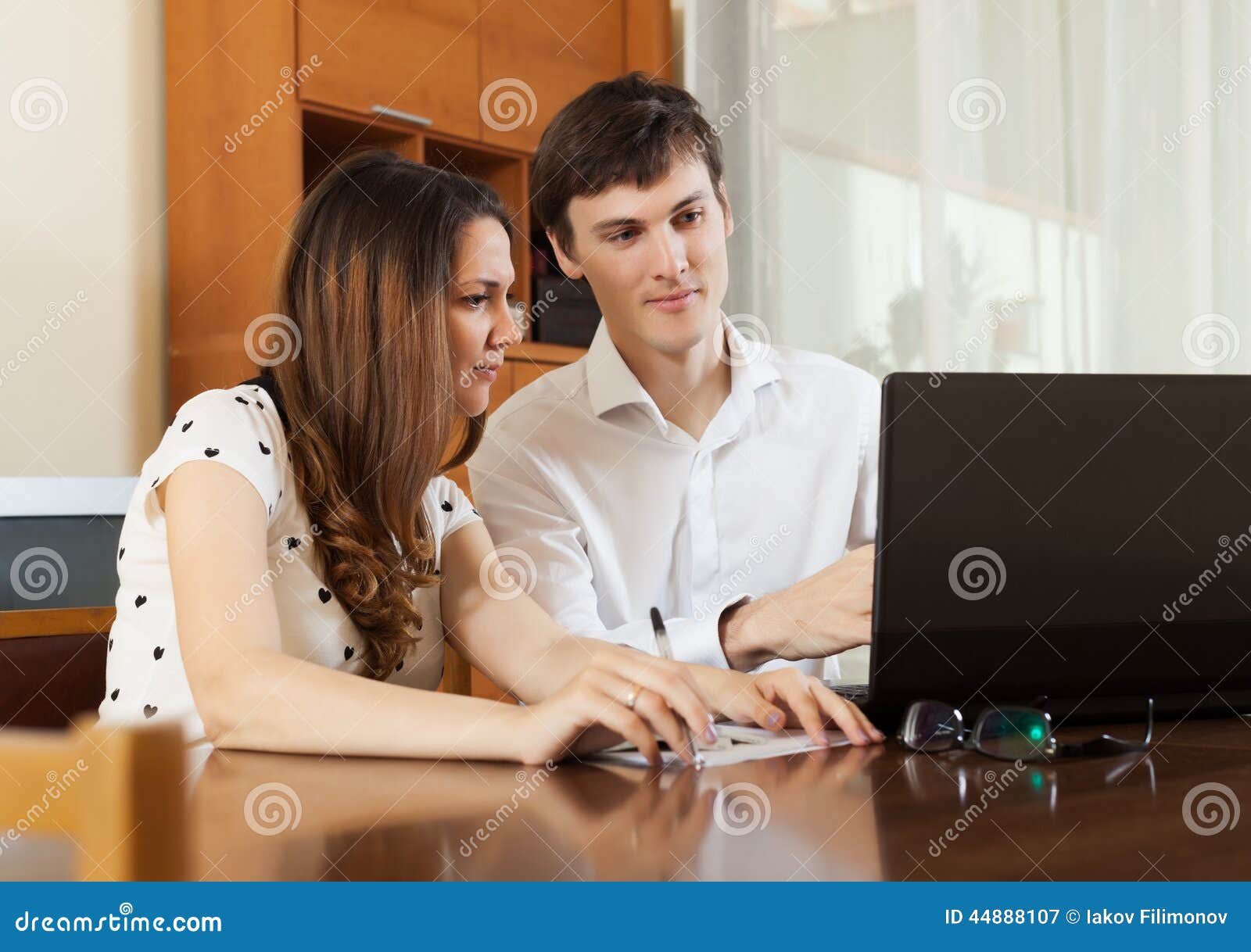Young Couple Looking Financial Documents in Laptop Stock Image - Image ...