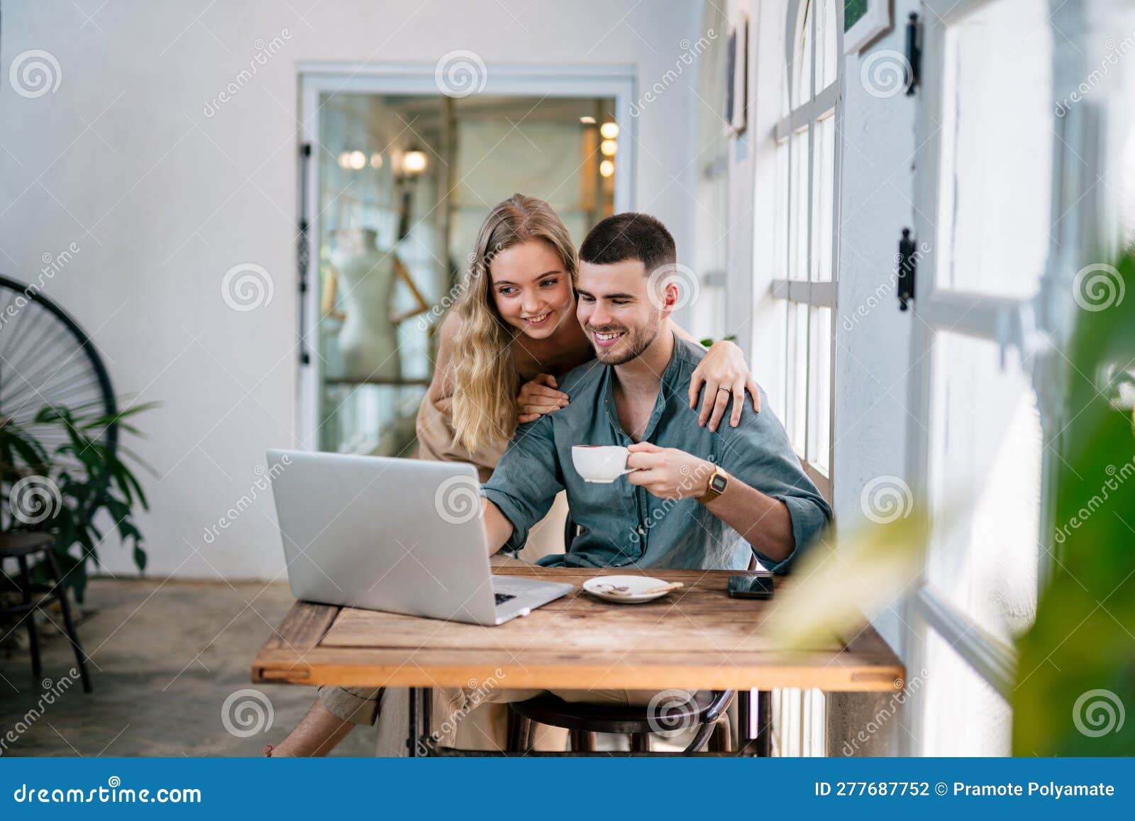 Young Couple Looking at Laptop at Workplace. the Concept of Couples ...