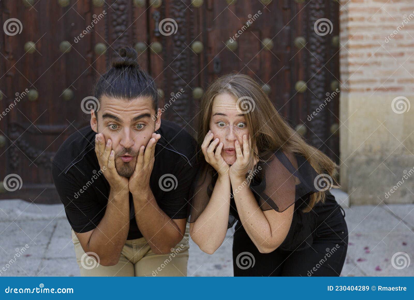 A Young Couple Making Expressions with Their Faces and Hands Stock ...
