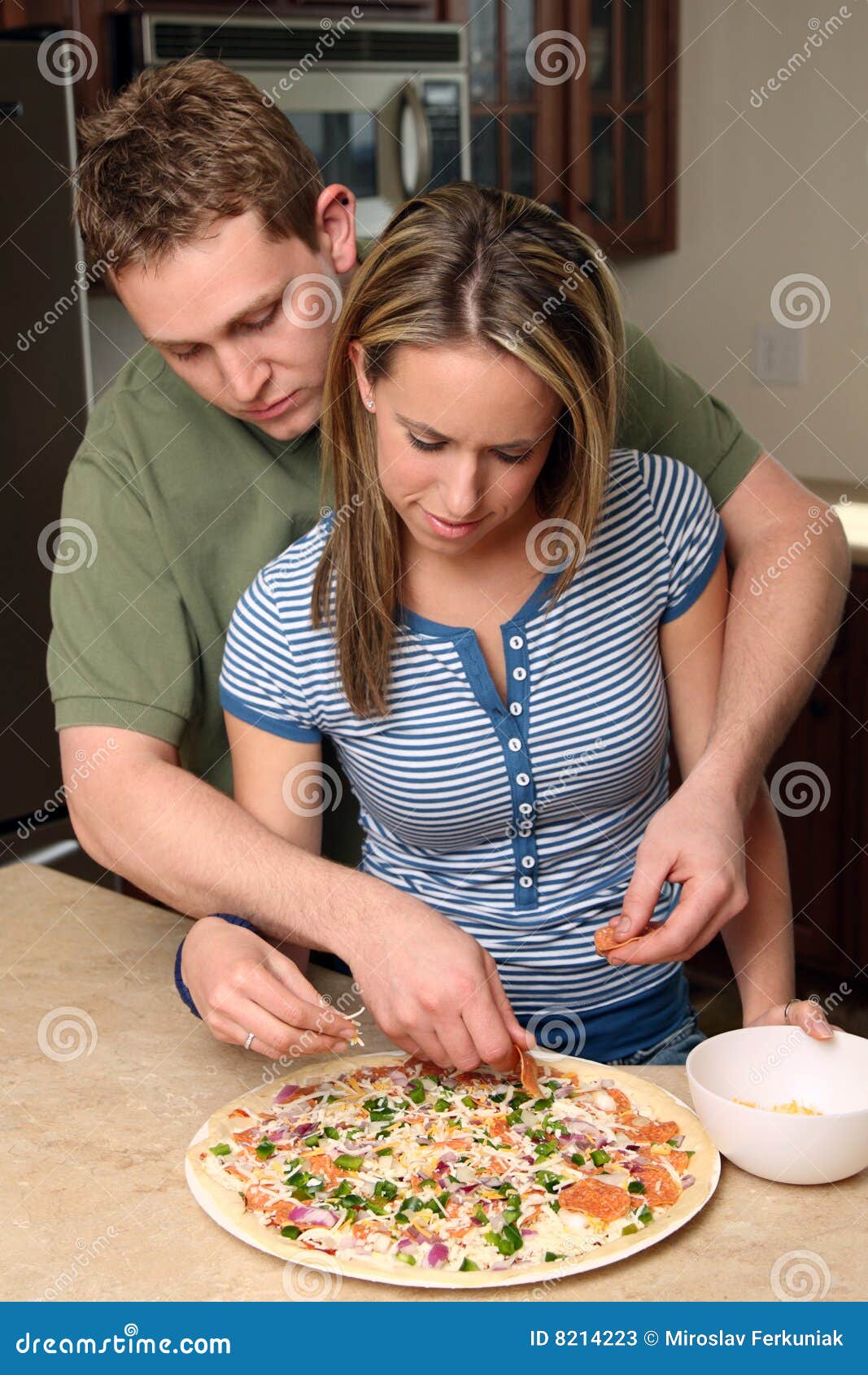 Young Couple Making Pizza stock image. Image of preparation - 8214223