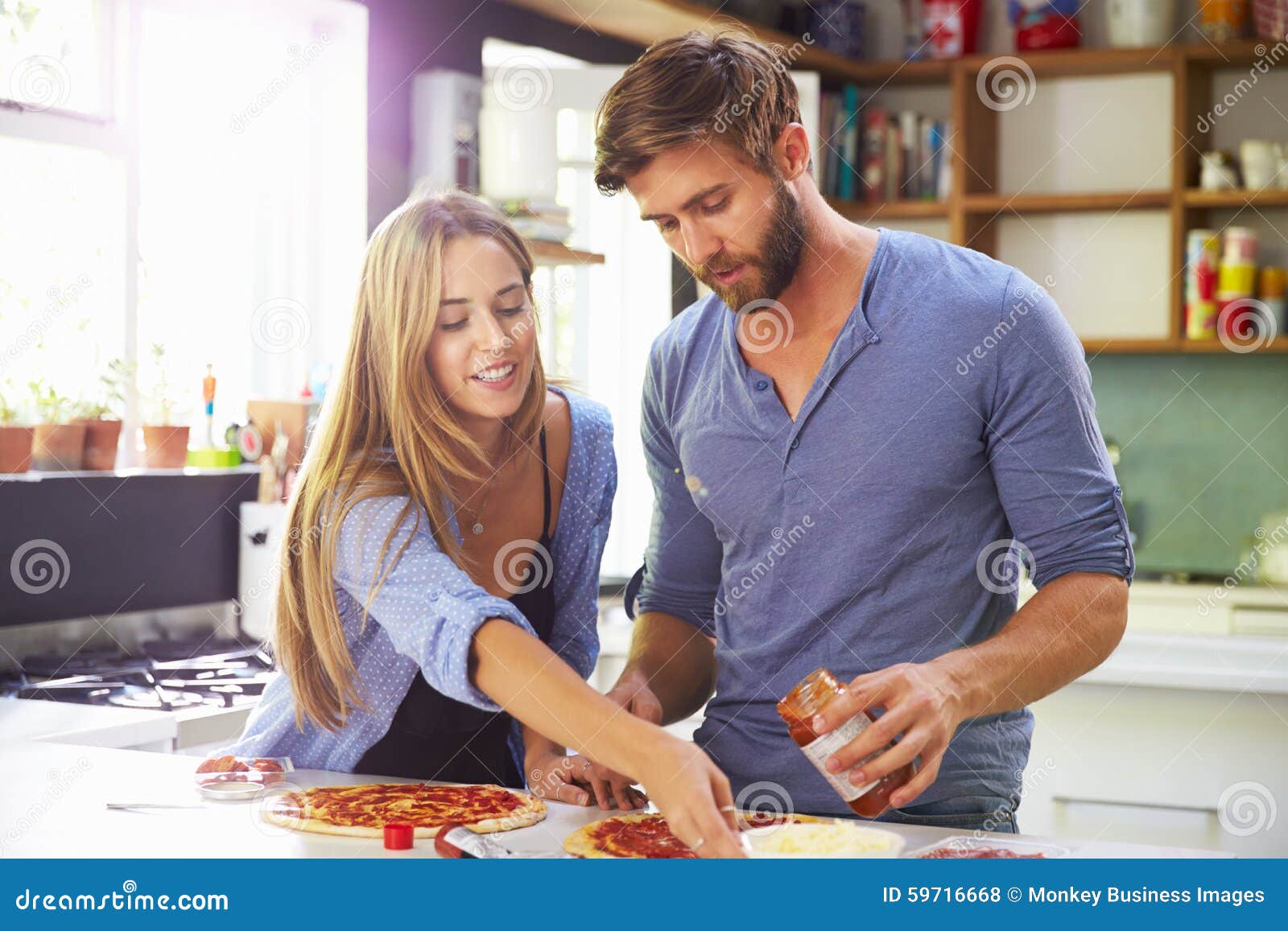 Young Couple Making Pizza in Kitchen Together Stock Photo - Image of ...