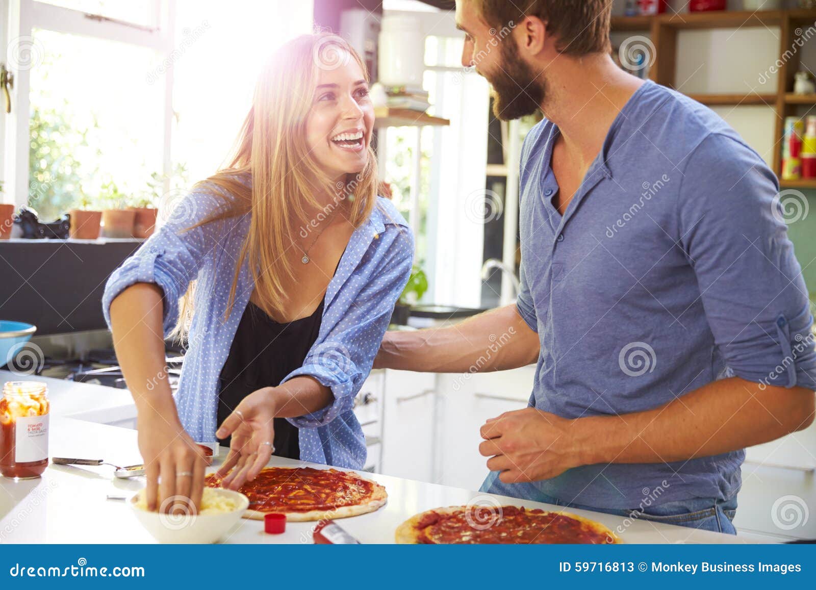 Young Couple Making Pizza in Kitchen Together Stock Image - Image of ...