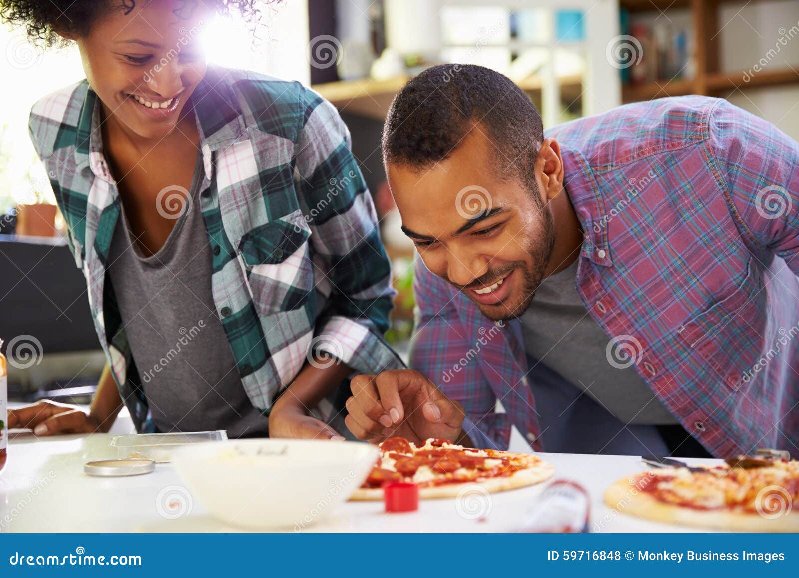 Young Couple Making Pizza in Kitchen Together Stock Photo - Image of ...