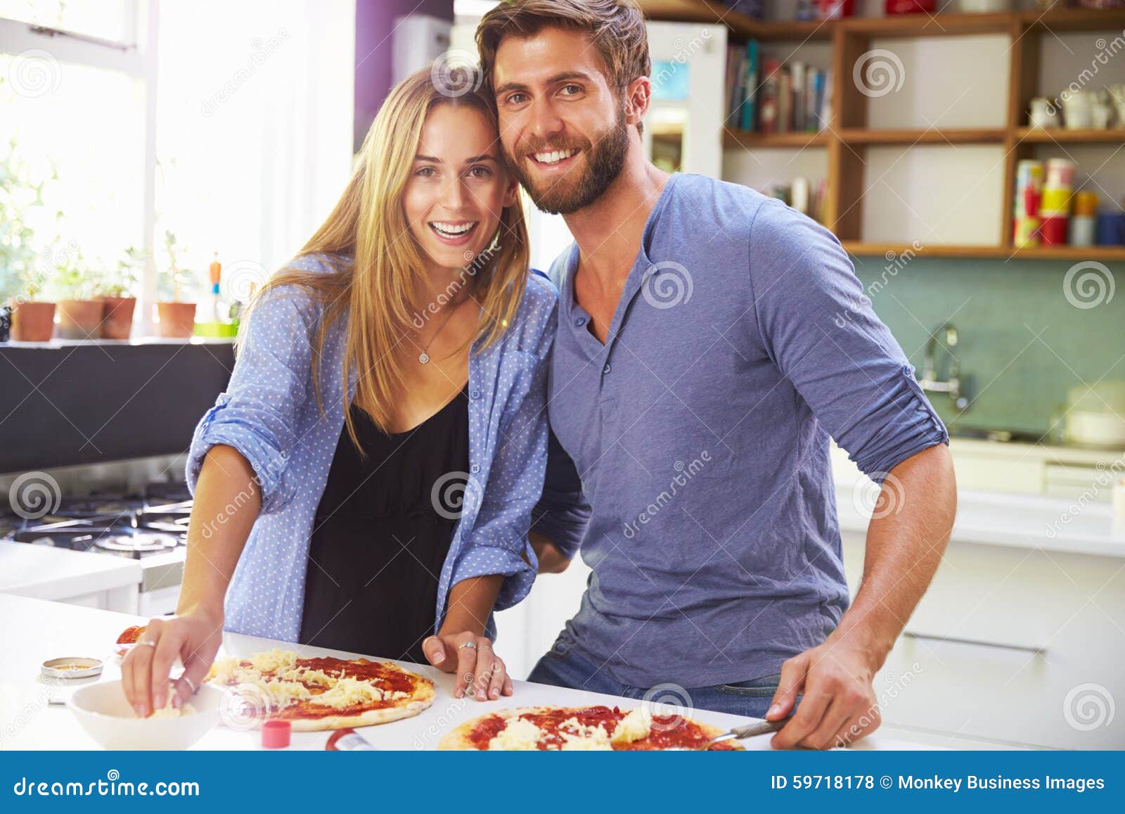 Young Couple Making Pizza in Kitchen Together Stock Photo - Image of ...