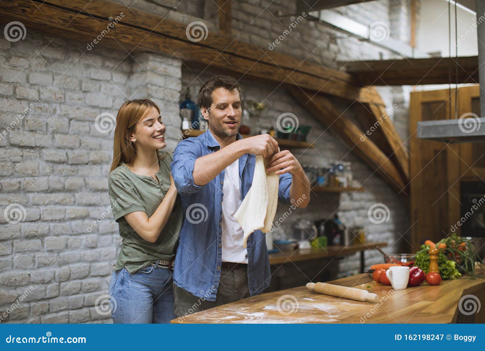 Young Couple Making Pizza in Rustic Kitchen Together Stock Image ...