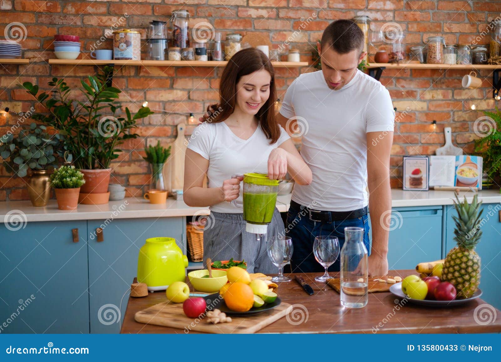 Young Couple Making Smoothie in Kitchen Stock Image - Image of citrus ...