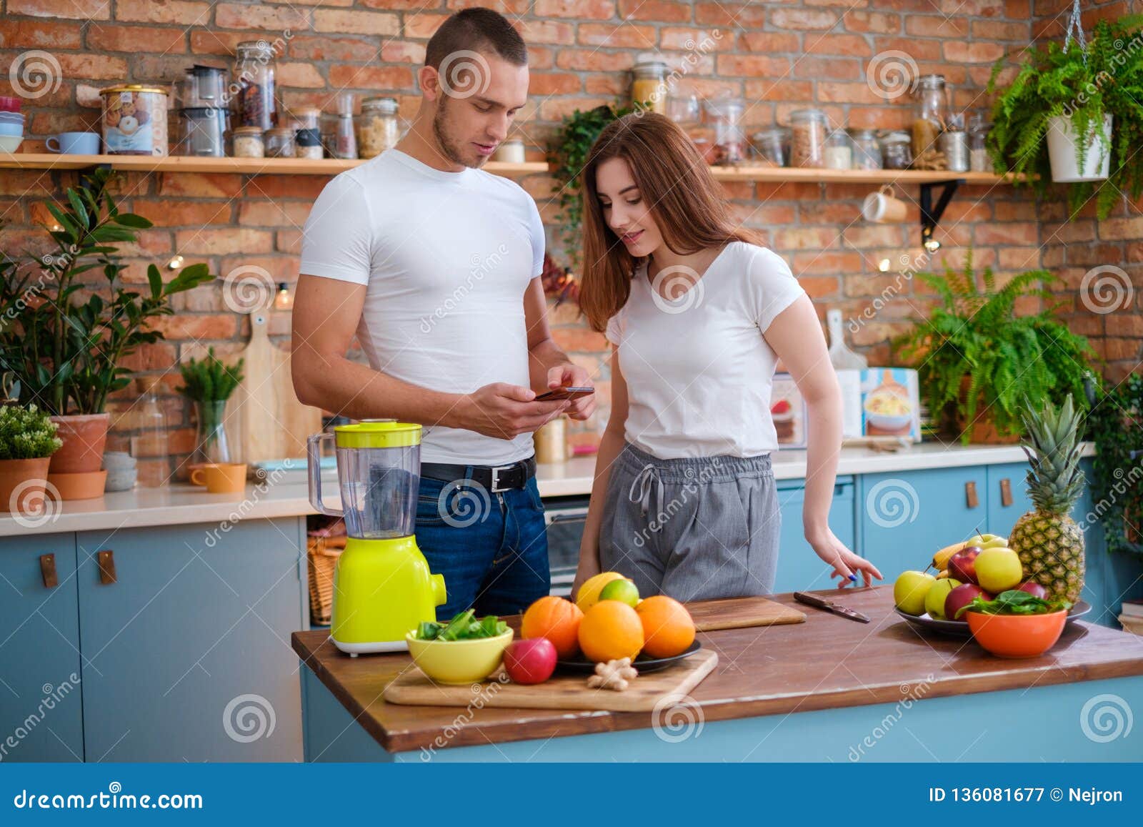 Young Couple Making Smoothie in Kitchen Stock Image - Image of enjoy ...