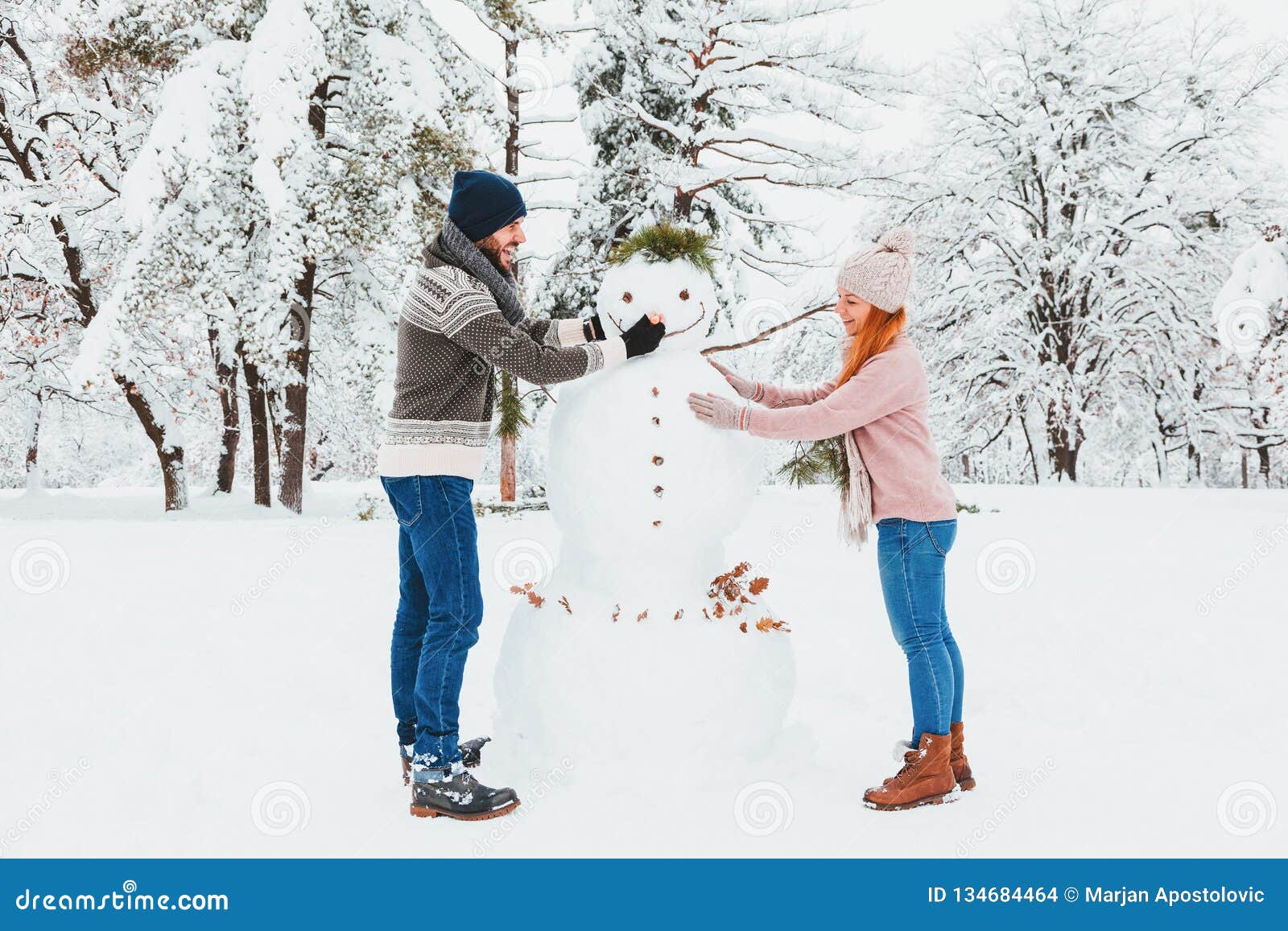 Young Couple Making Snowman in the Park Stock Photo - Image of enjoying ...