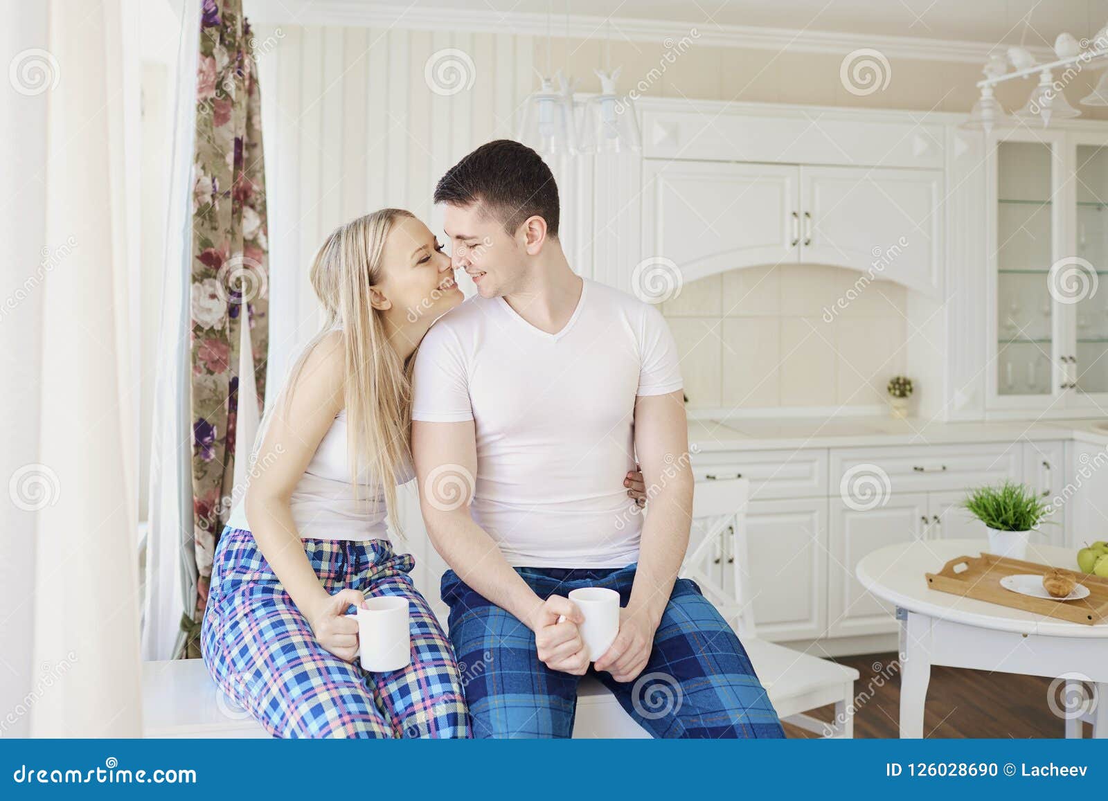 Young Couple in the Morning Embrace in the Kitchen. Stock Photo - Image ...