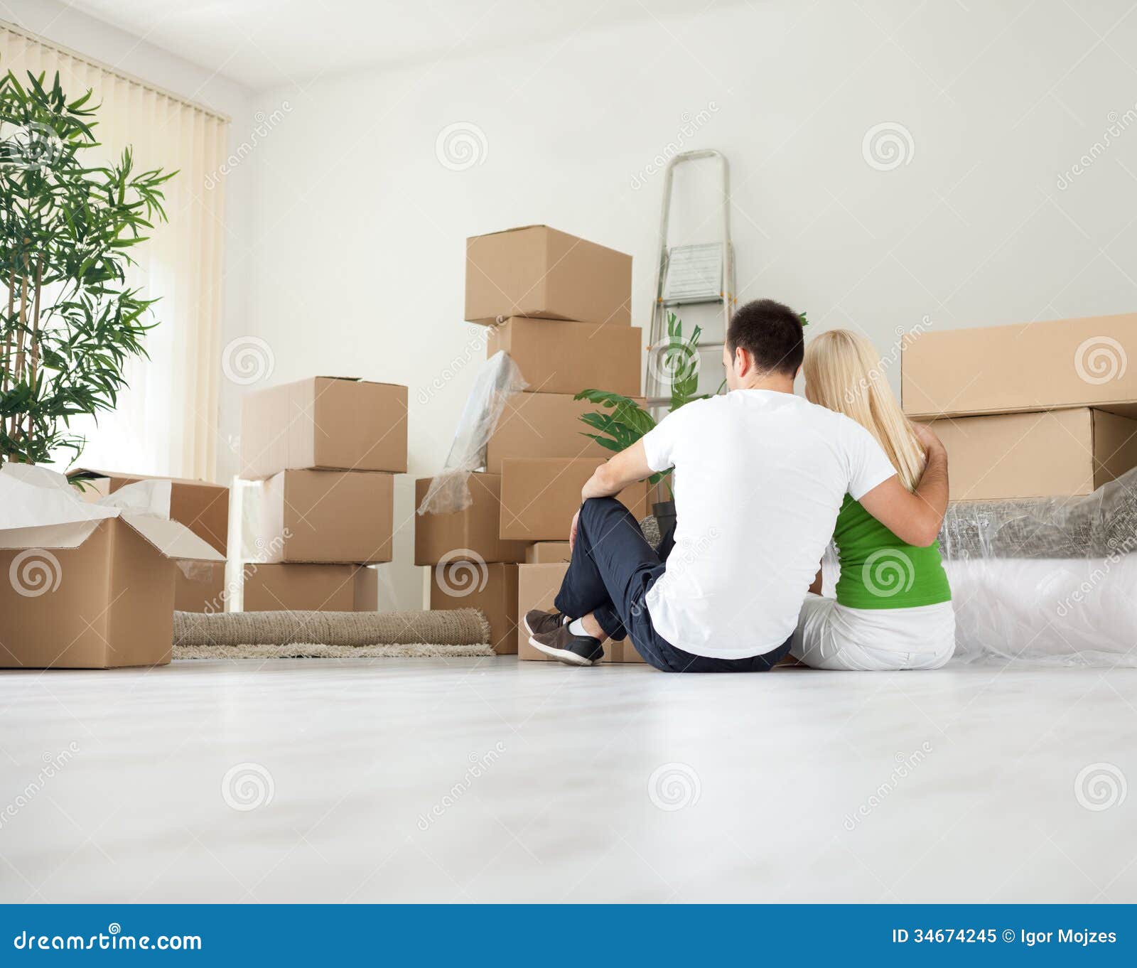 Young couple moving house stock image. Image of attractive - 34674245