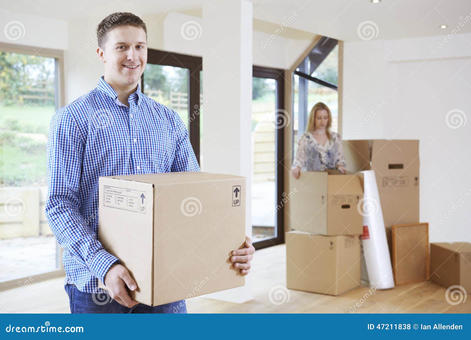 Young Couple Moving into New Home Together Stock Photo - Image of happy ...