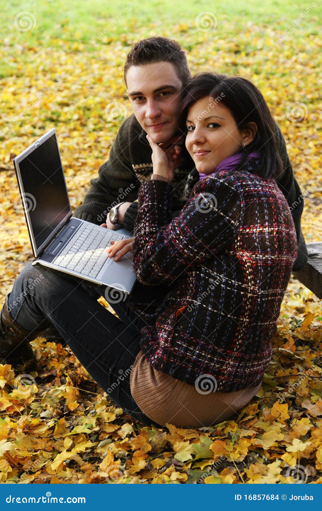 Young couple with notebook stock photo. Image of computer - 16857684