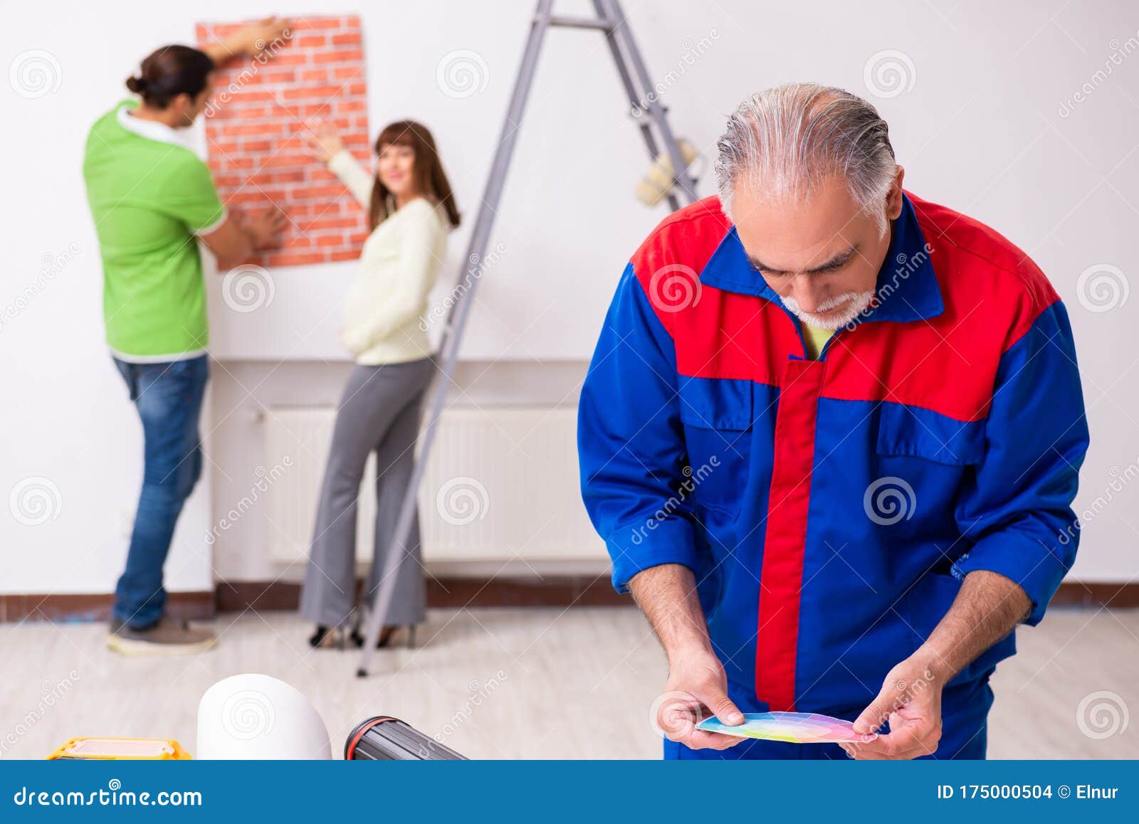 Young Couple and Old Contractor in Home Renovation Concept Stock Photo ...