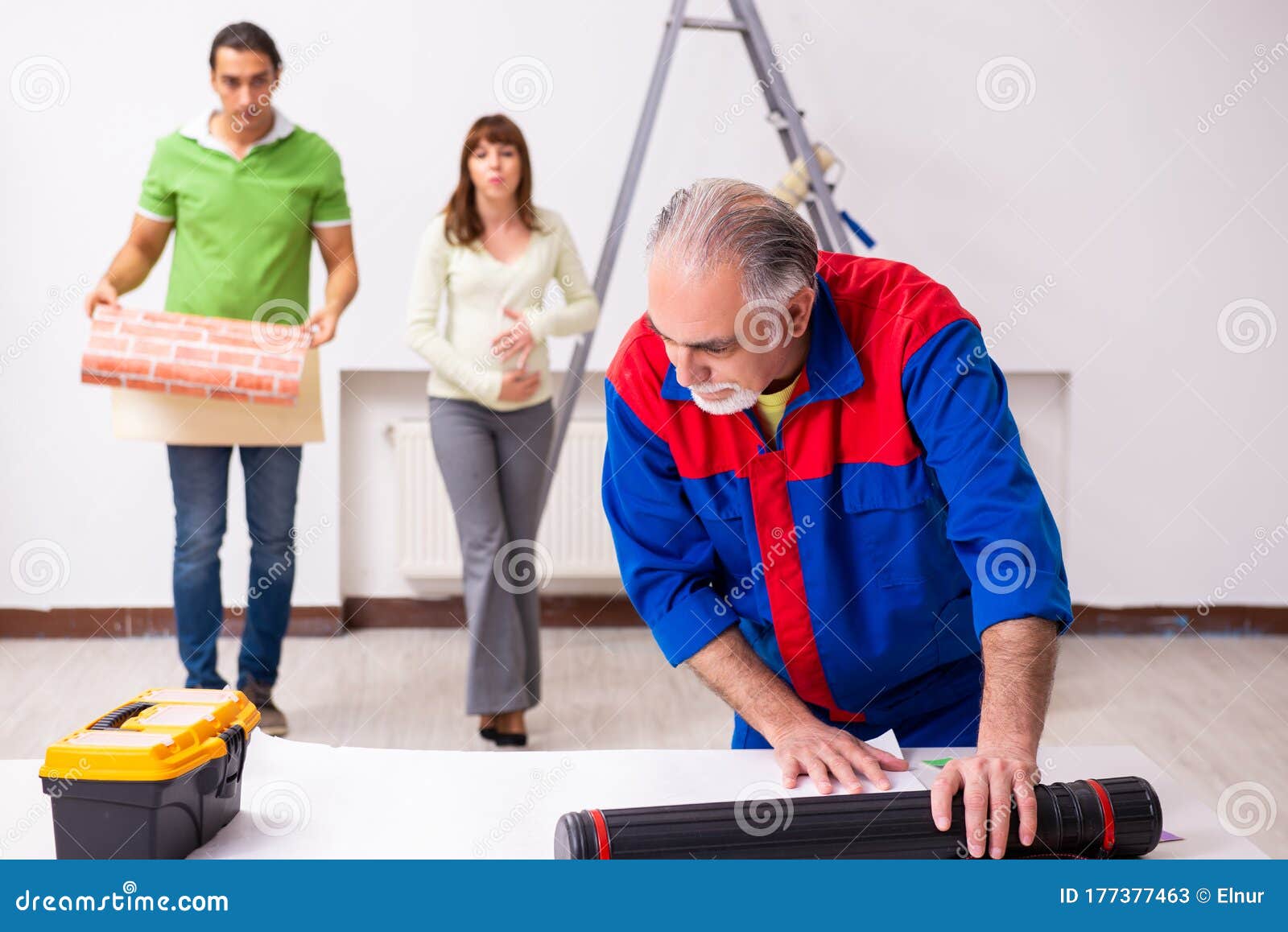 Young Couple and Old Contractor in Home Renovation Concept Stock Image ...