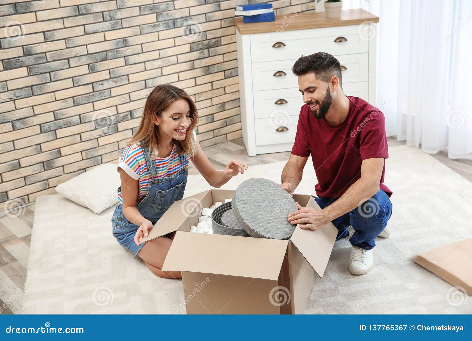 Young Couple Opening Parcel on Floor Stock Image - Image of open, order ...