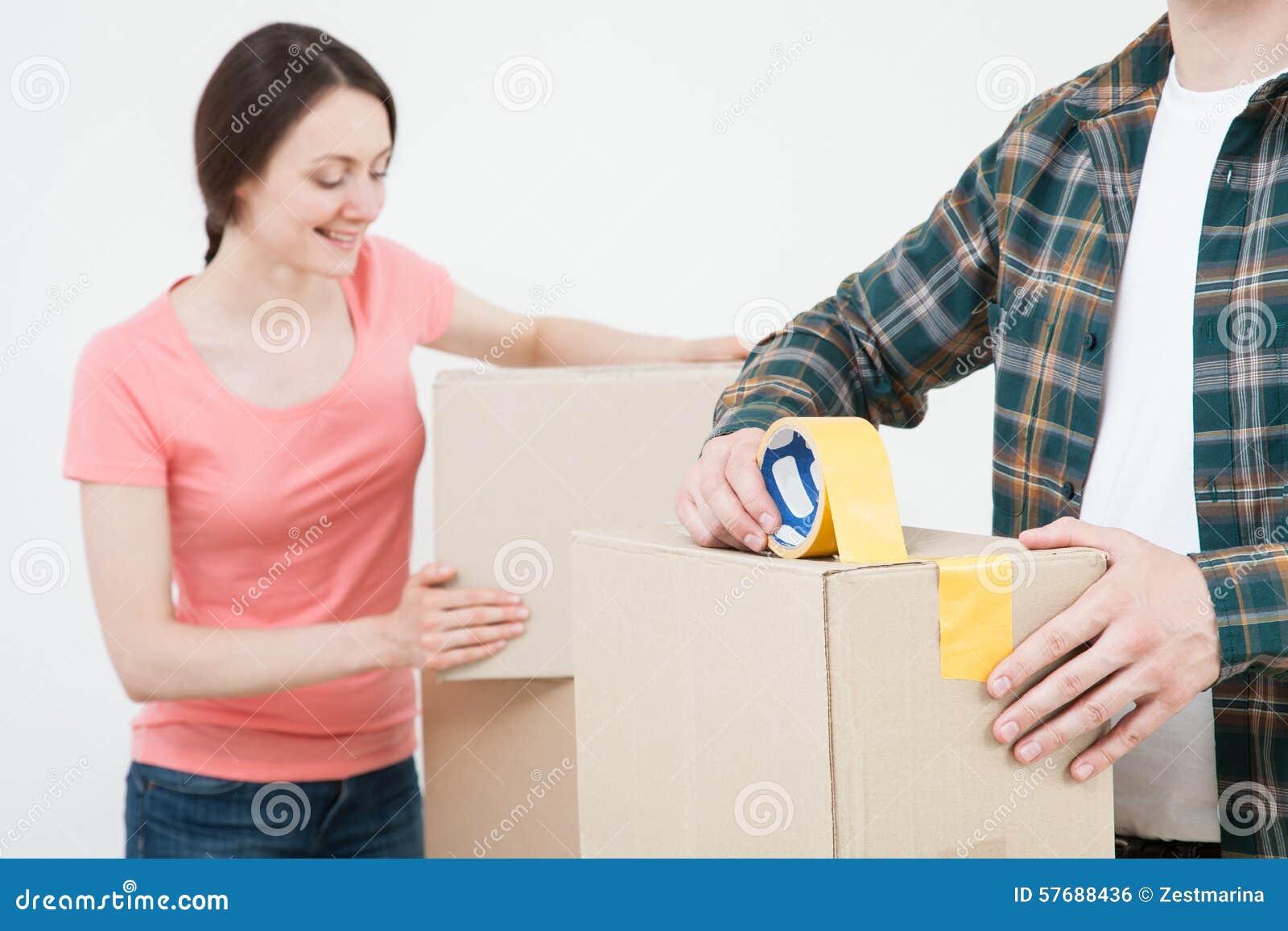 Young Couple Packing Their Things in Cardboard Boxes Stock Photo ...