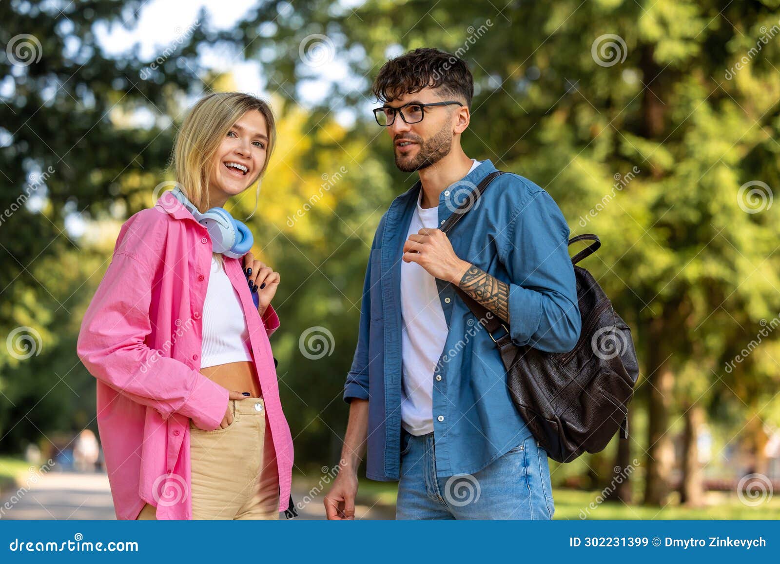 Young Couple in the Park Looking Happy and Contented Stock Image ...