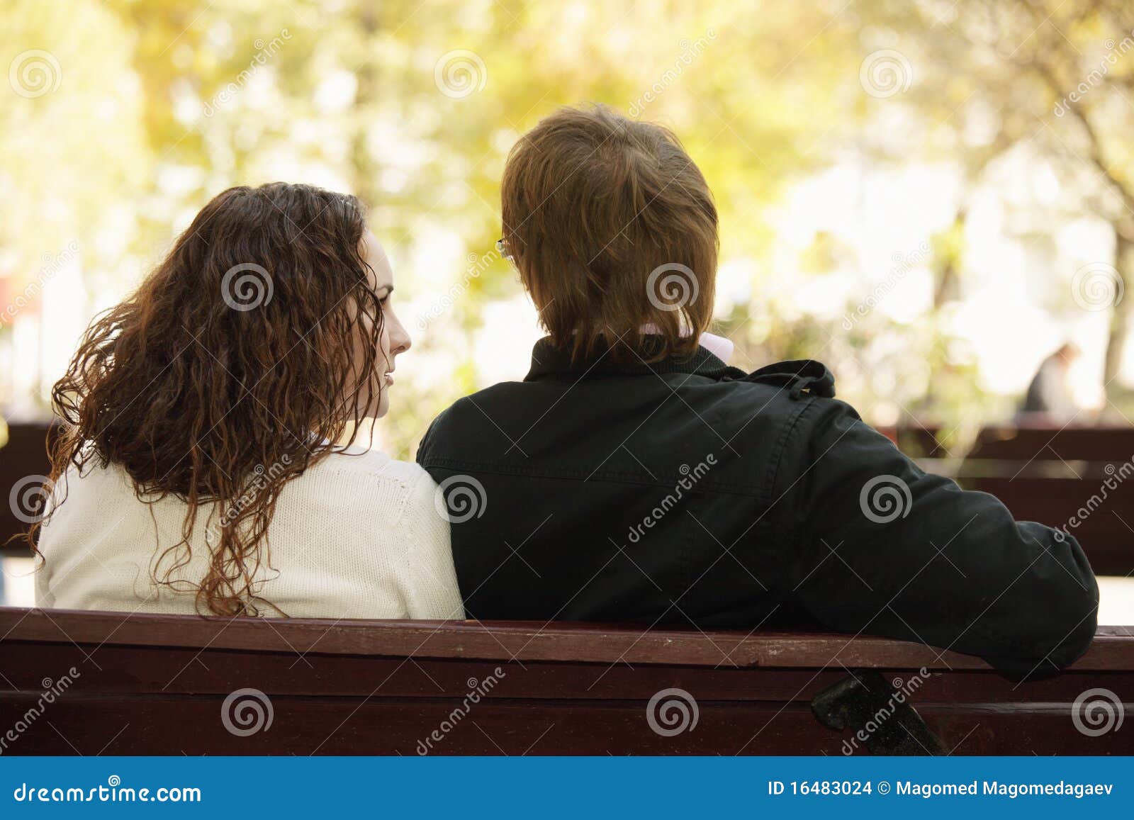 Young Couple in Park Rear View Stock Photo - Image of jacket, sweater ...