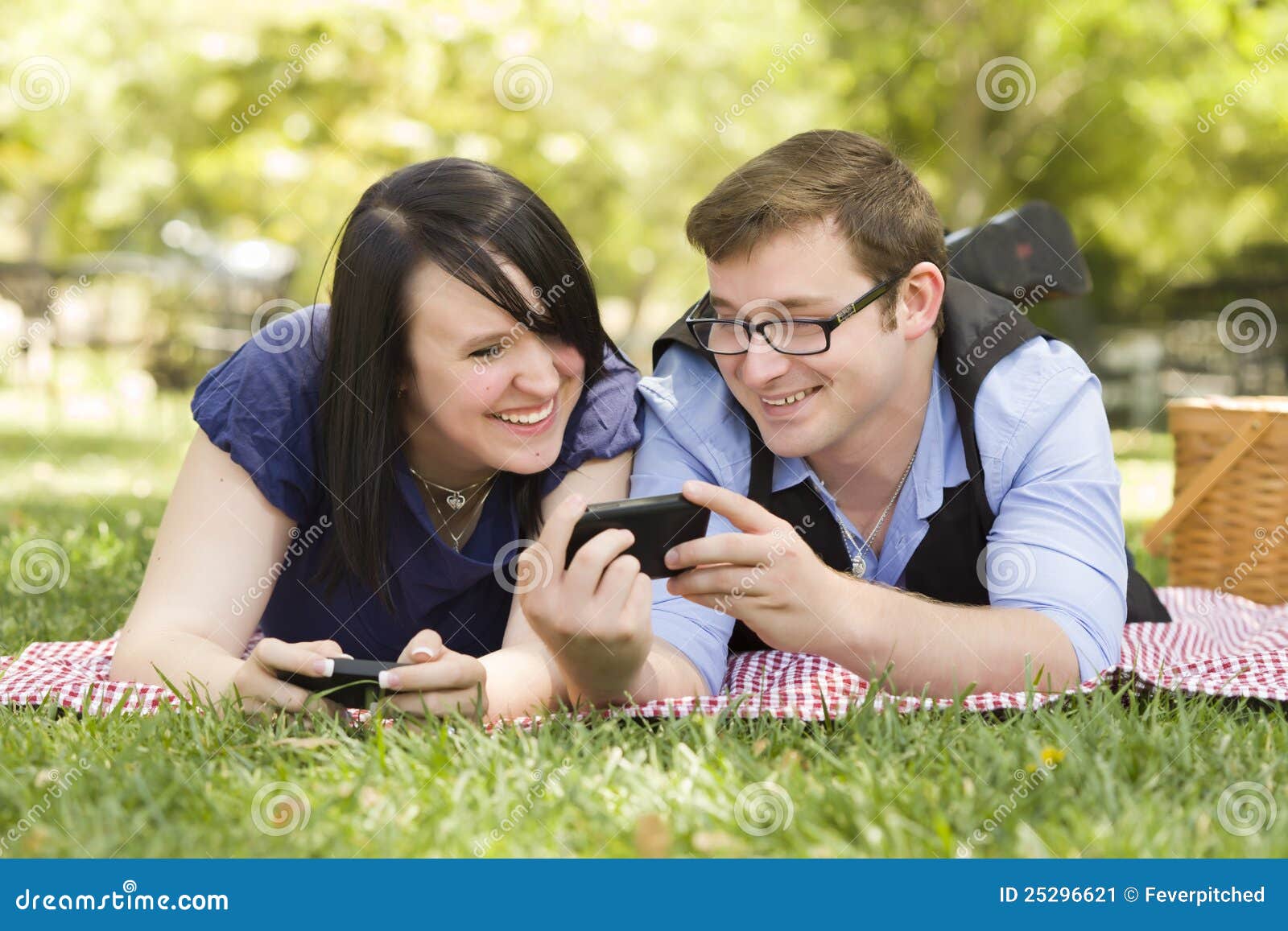 Young Couple at Park Texting Together Stock Image - Image of playing ...