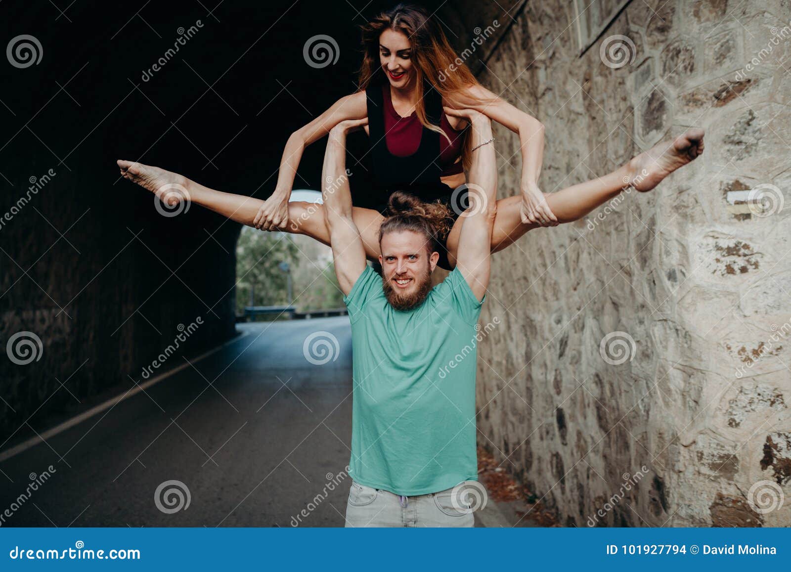 Man Holding And Elevating Woman With The Arms In A Gymnastics Dance