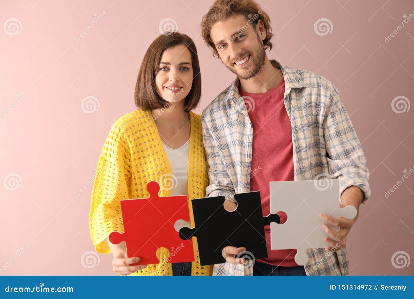 Young Couple with Pieces of Jigsaw Puzzle on Color Background Stock ...