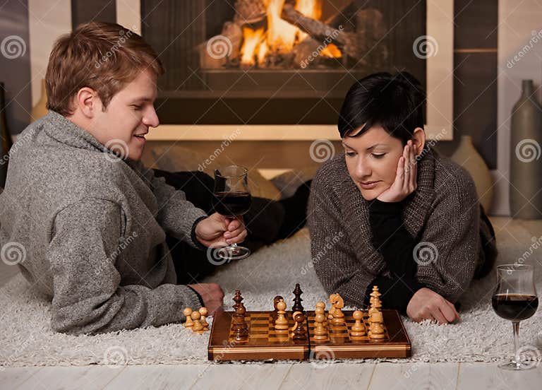 Young couple playing chess stock photo. Image of cheerful - 11977164