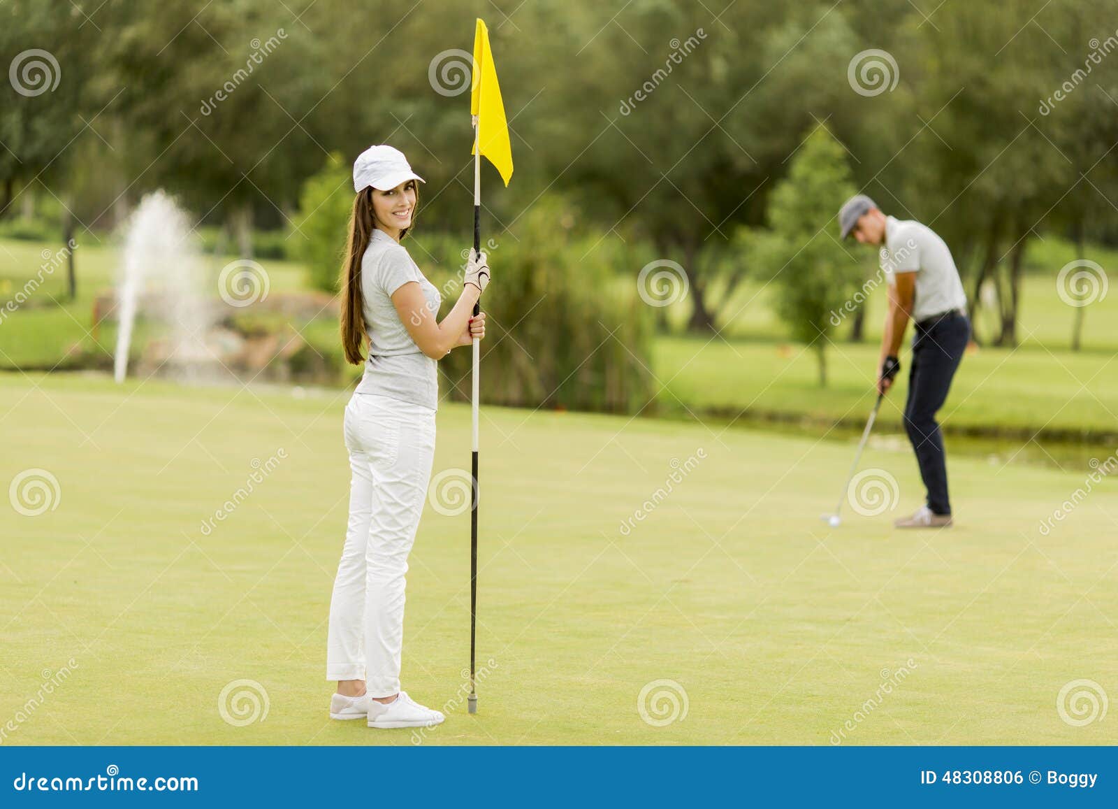 Young couple playing golf stock photo. Image of male - 48308806