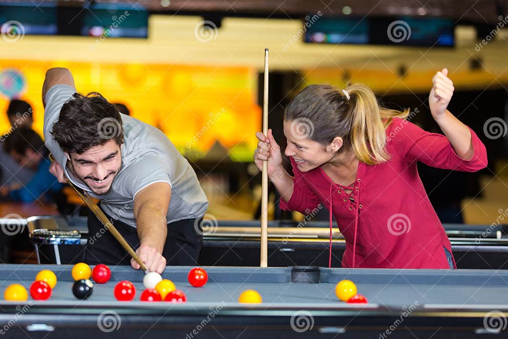 Young couple playing pool stock photo. Image of beauty - 258796500