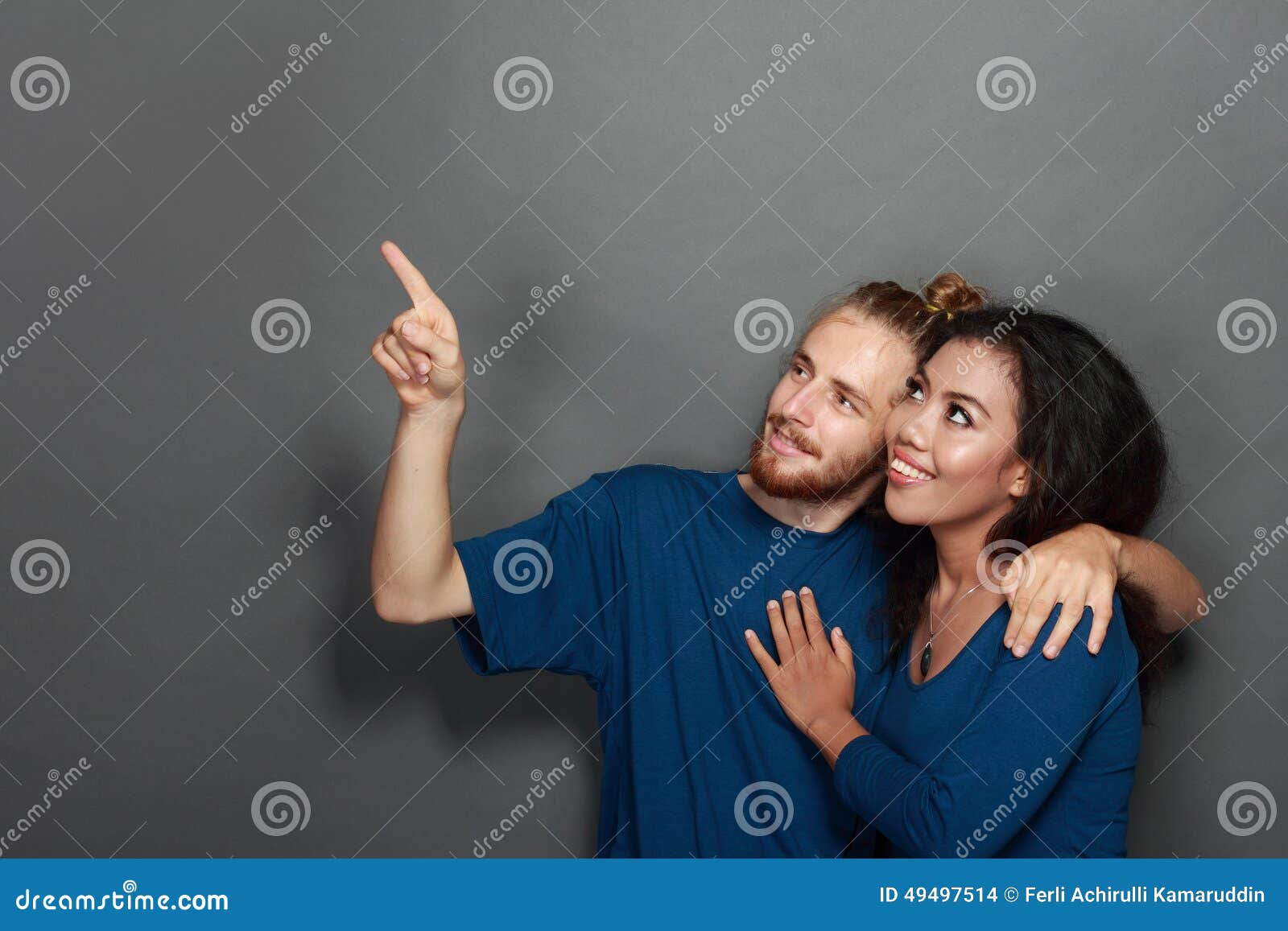 Young couple pointing up stock photo. Image of casual - 49497514