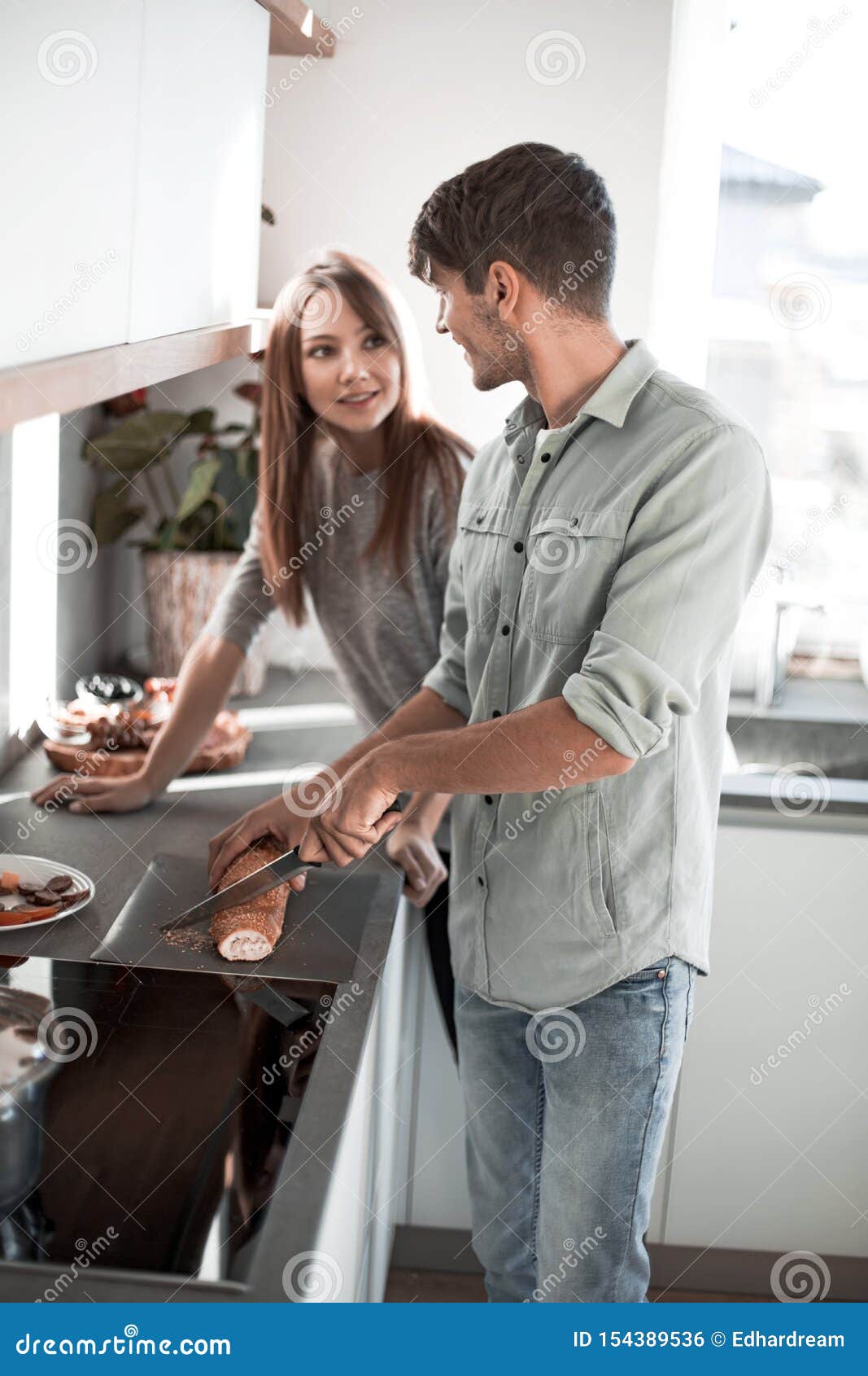 Young Couple is Preparing Breakfast in Their Kitchen. Stock Photo ...