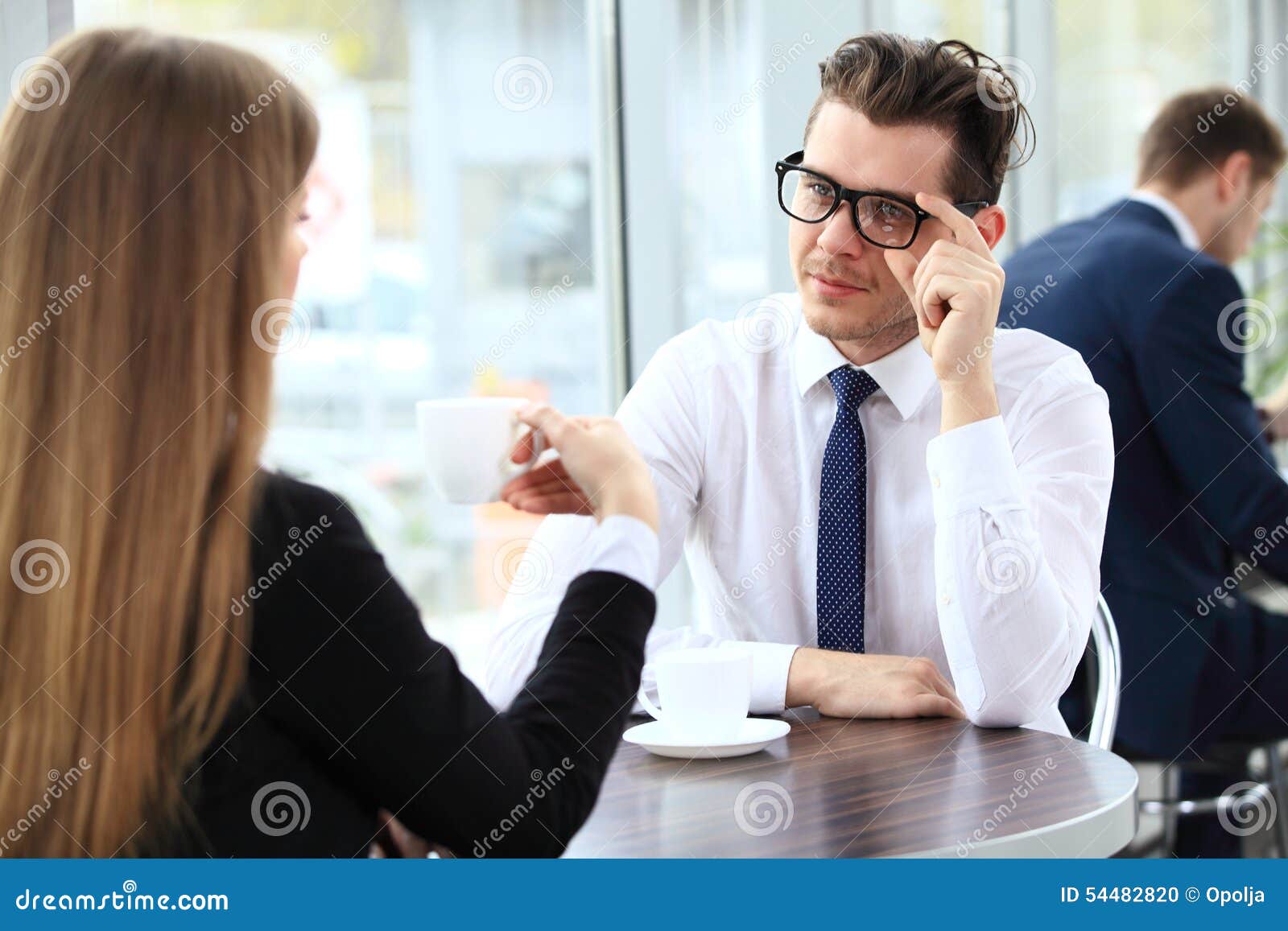 Young Couple of Professionals Chatting during a Coffeebreak Stock Photo ...