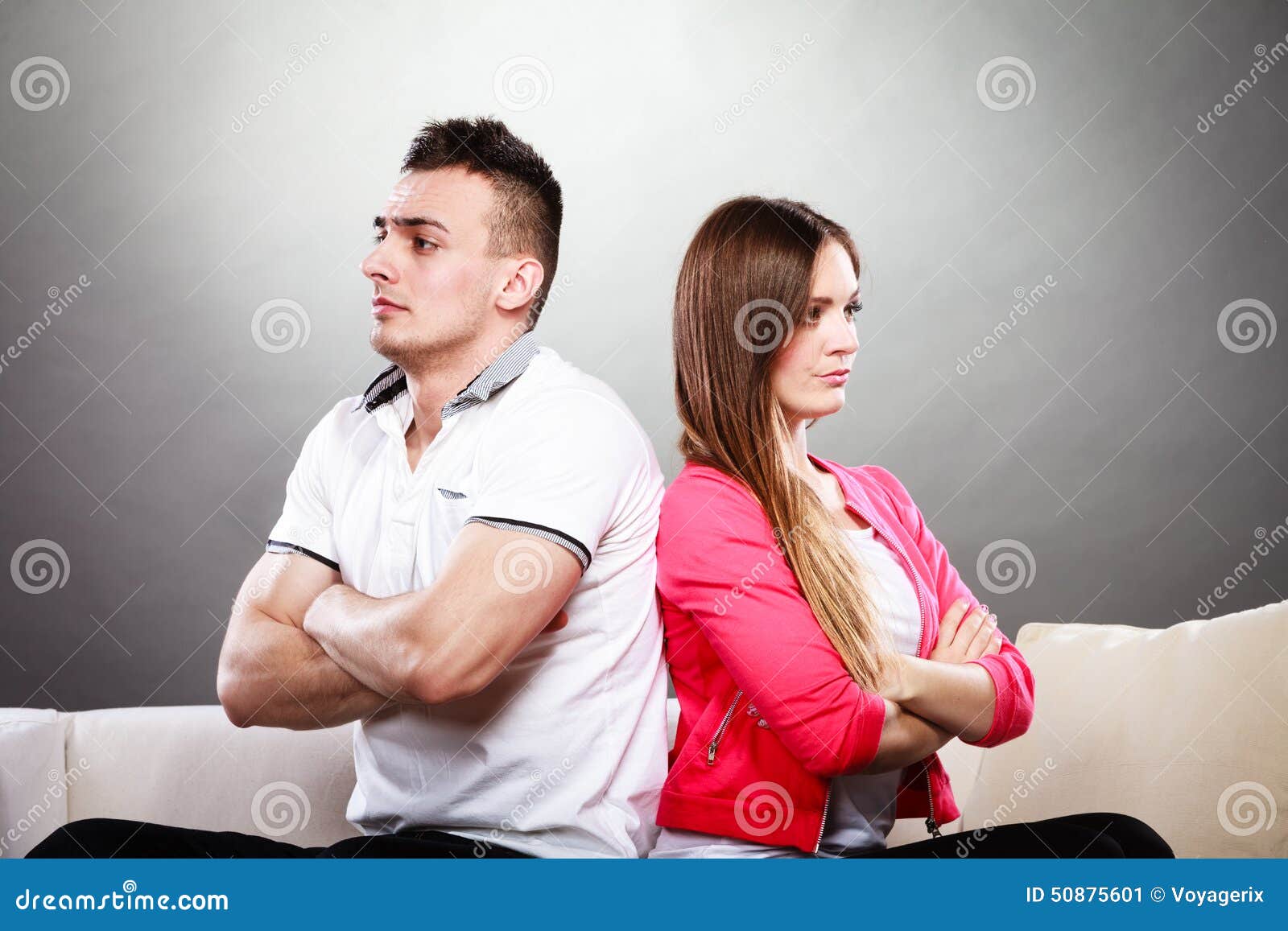 Young Couple After Quarrel Sitting On Sofa Back To Back Stock Image