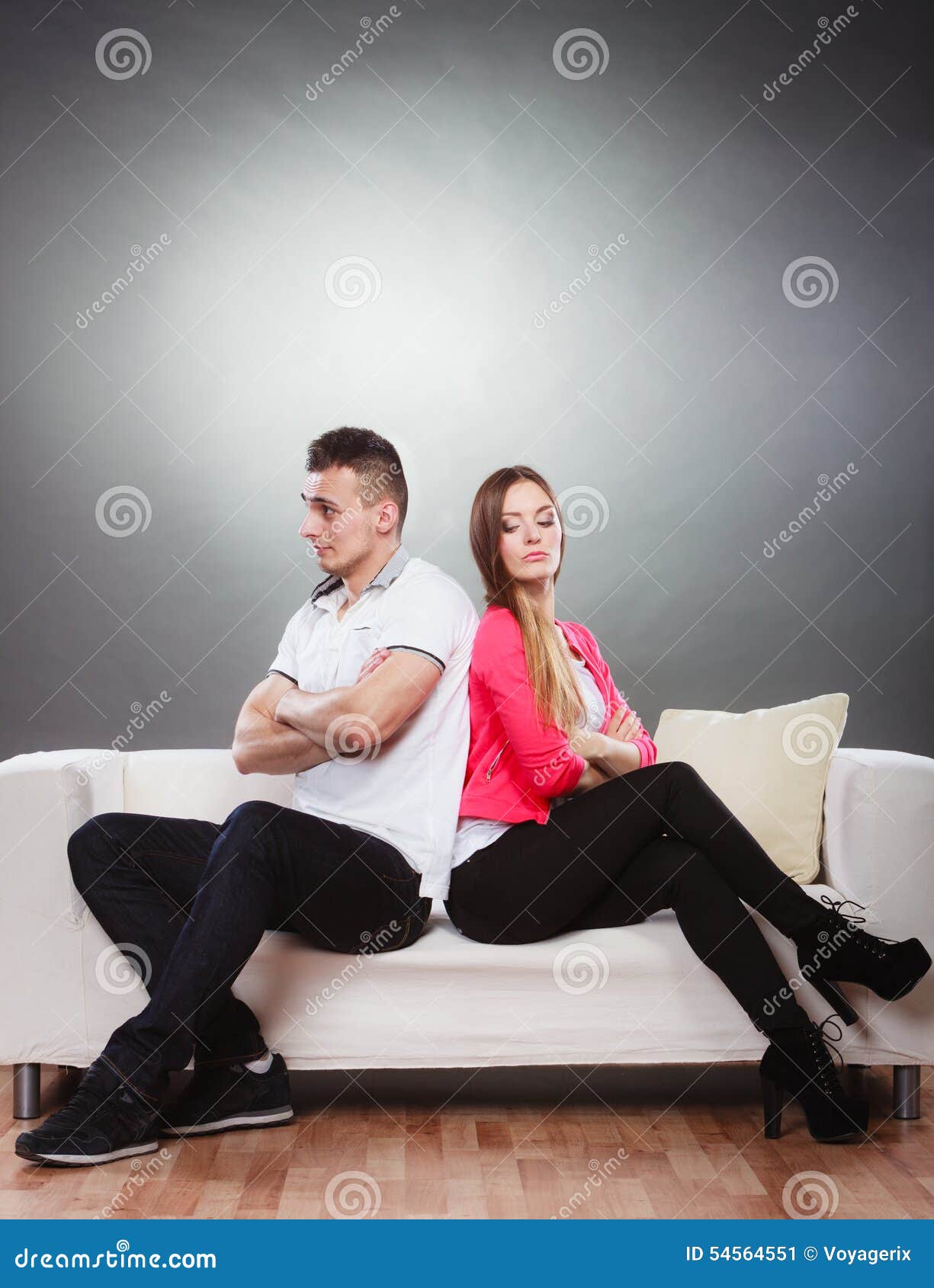 Young Couple After Quarrel Sitting On Sofa Back To Back Stock Image