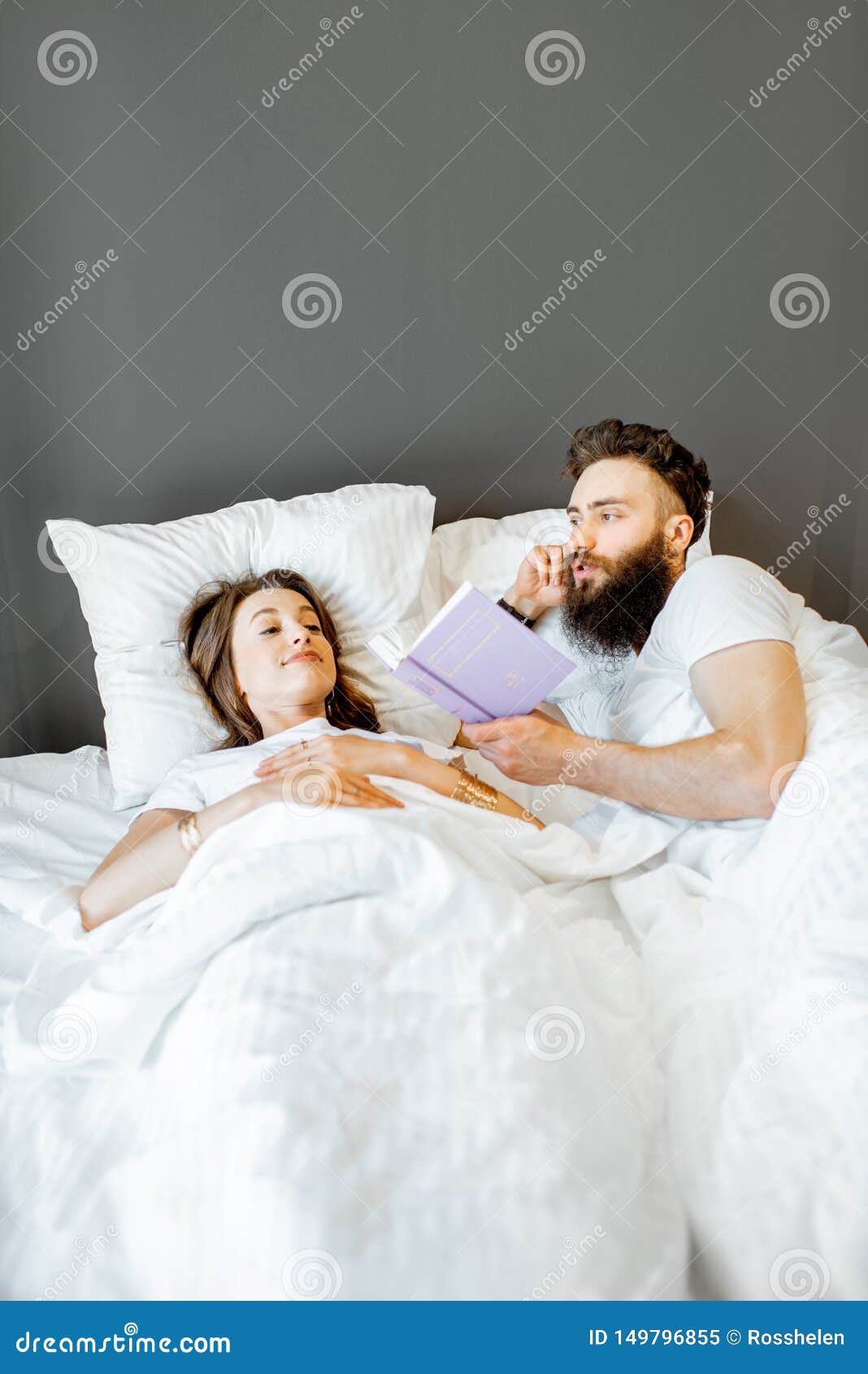 Young Couple Reading Book In The Bed Stock Image Image Of People