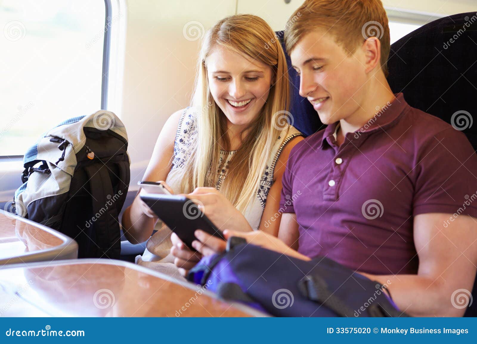 Young Couple Reading a Book on Train Journey Stock Photo - Image of ...