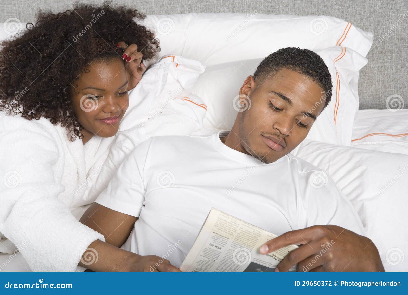Young Couple Reading Newspaper Together Stock Photo - Image of bedroom ...
