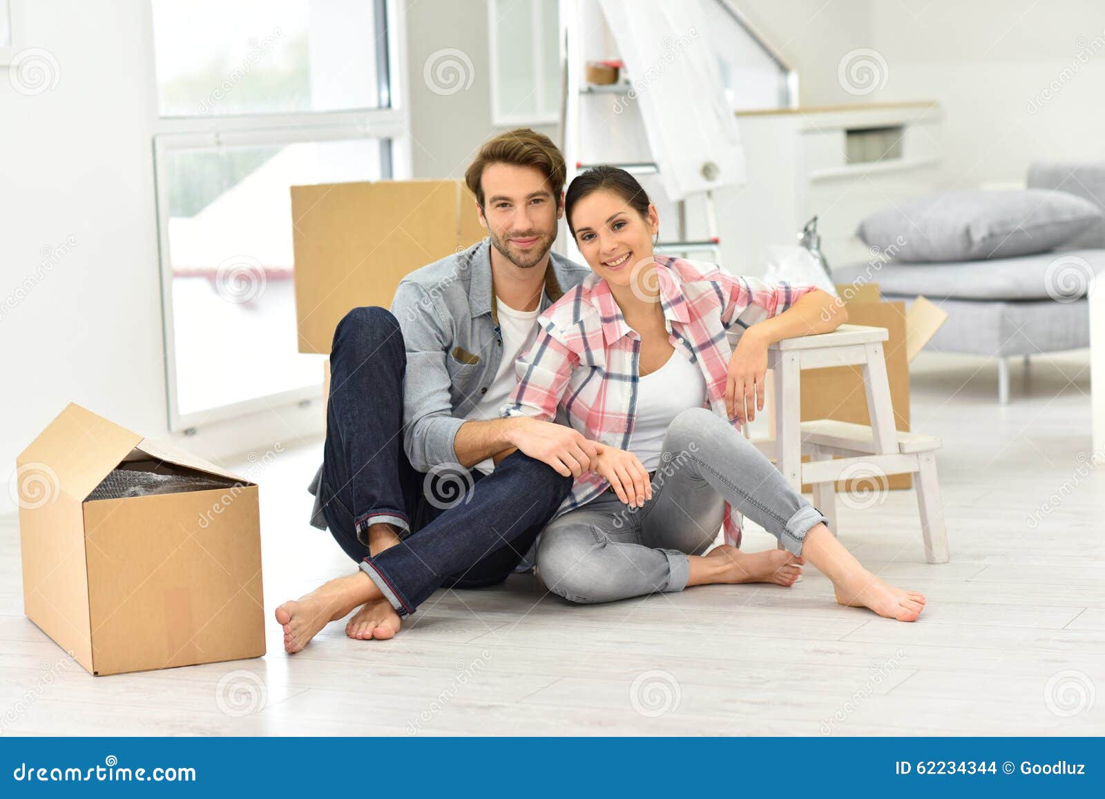 Young Couple Recently Moved into New Home Stock Photo - Image of couple ...