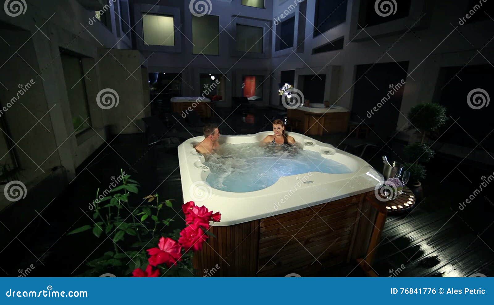 Young Couple Relaxed in Jacuzzi with Roses and Champagne in the Front ...