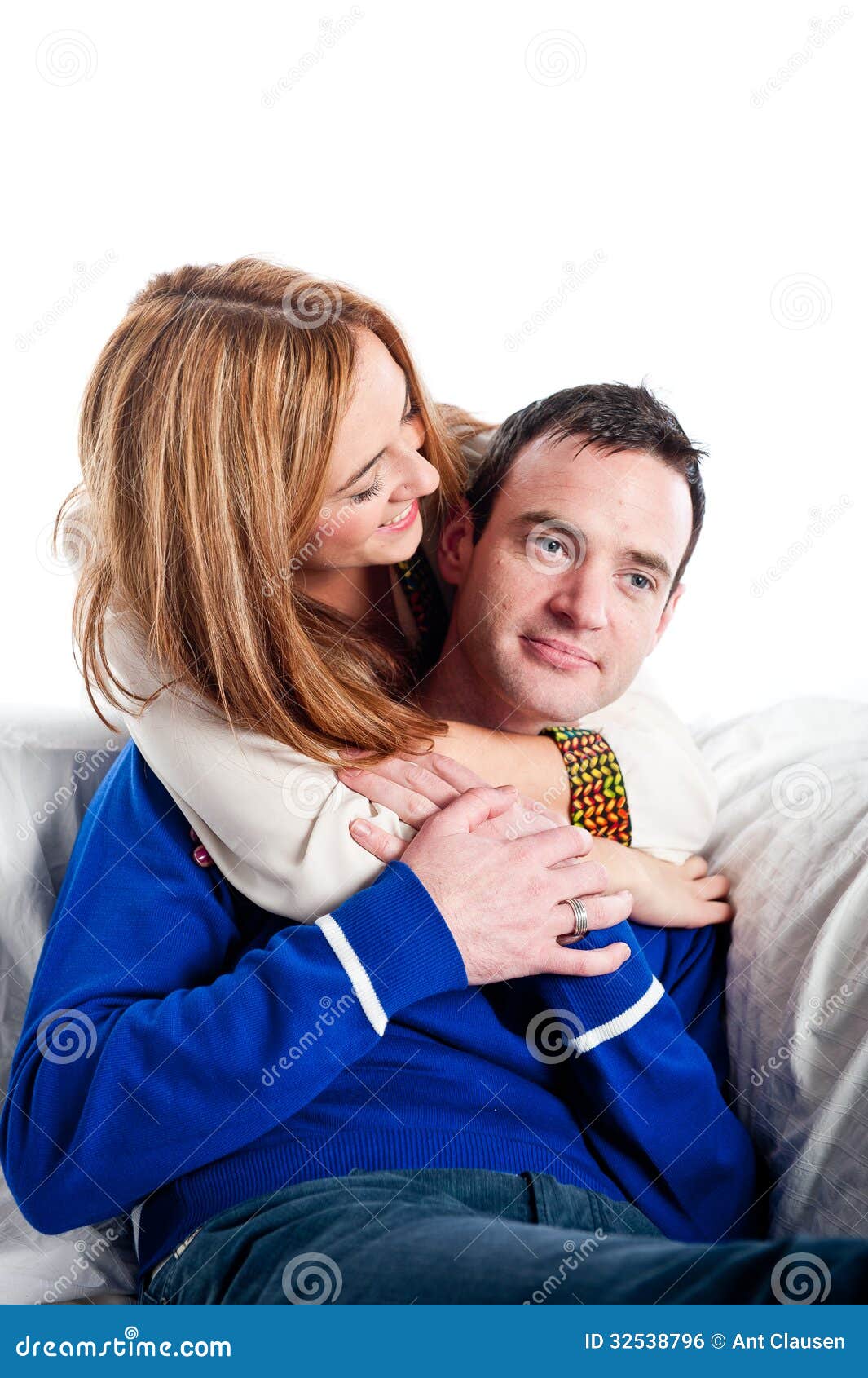 Young Couple Relaxing and Cuddling Together on the Sofa Stock Photo ...