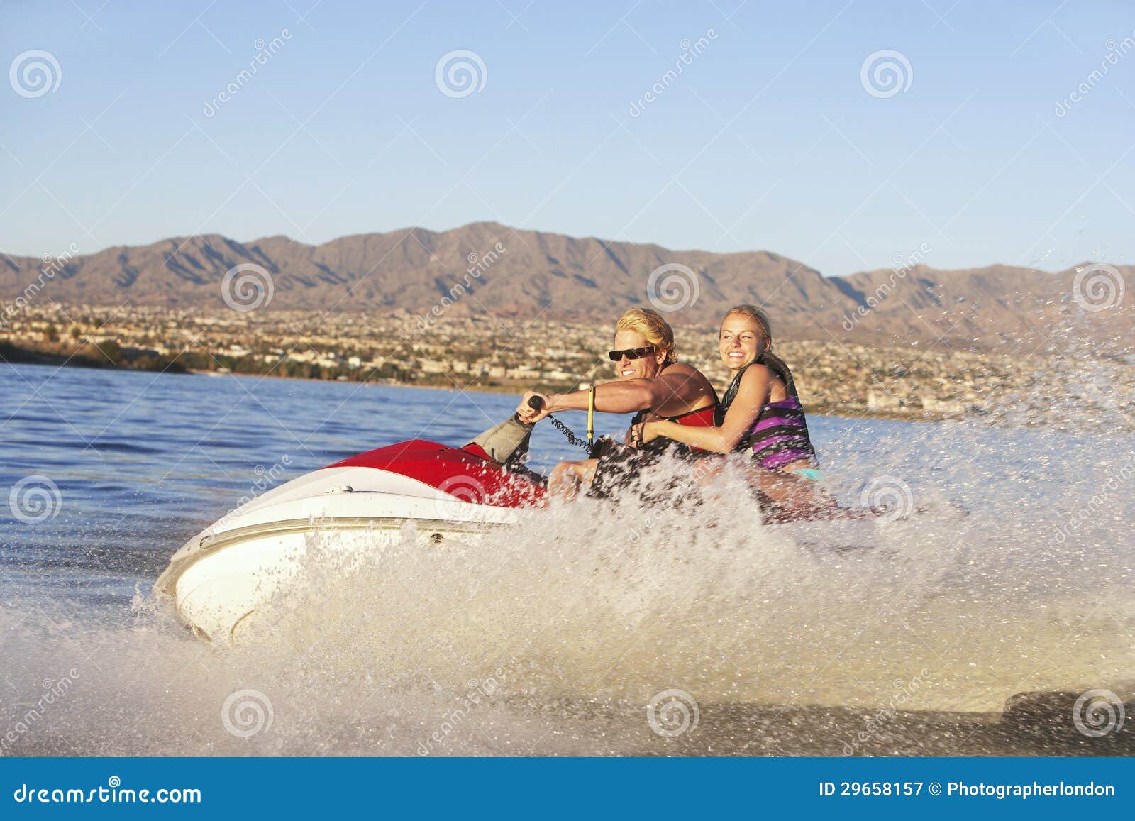 Young Couple Riding PWC stock image. Image of riding - 29658157