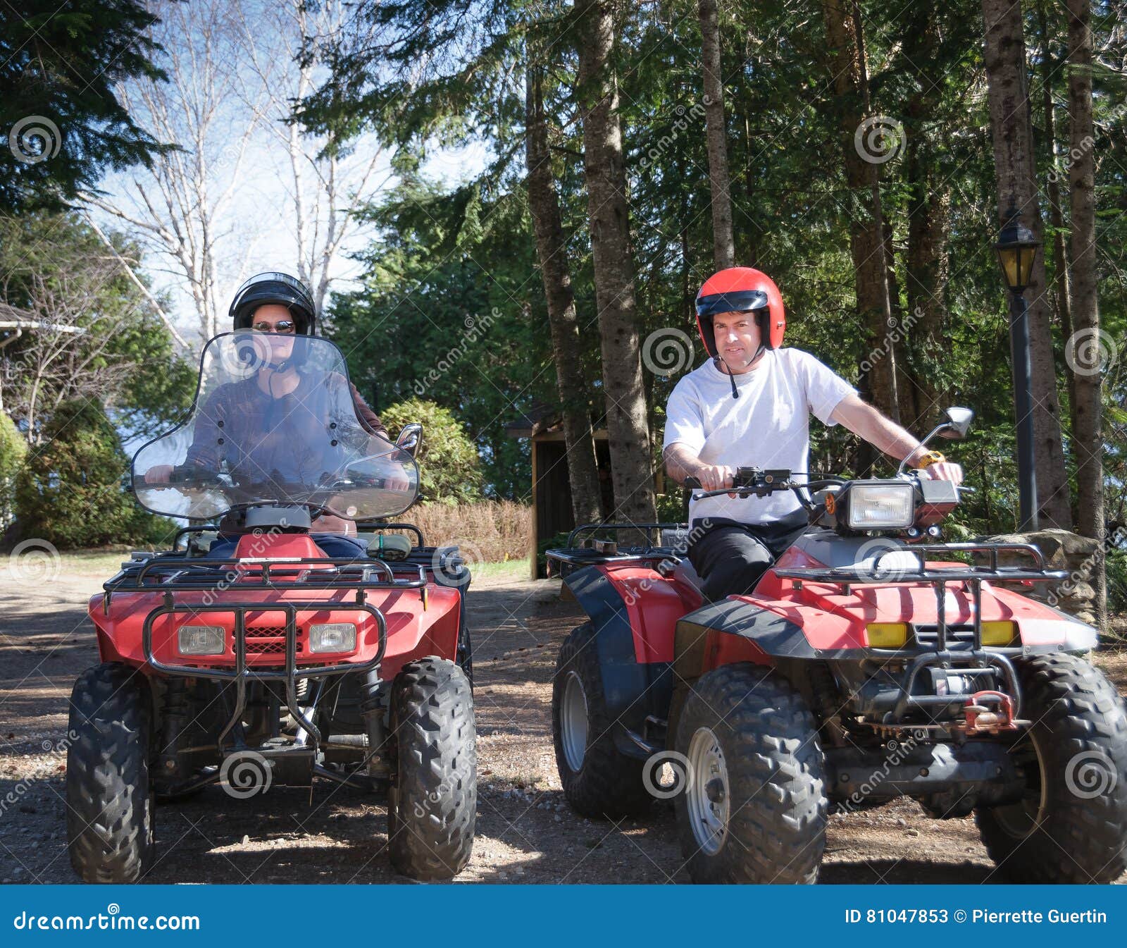 Young couple riding a quad stock image. Image of helmet - 81047853