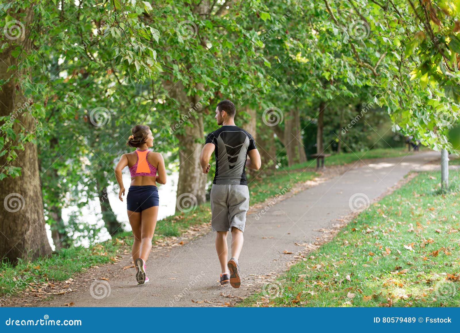 Young Couple Running in Early Morning at the Park Stock Image - Image ...