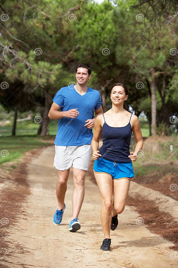 Young Couple Running in Park Stock Photo - Image of enjoying ...