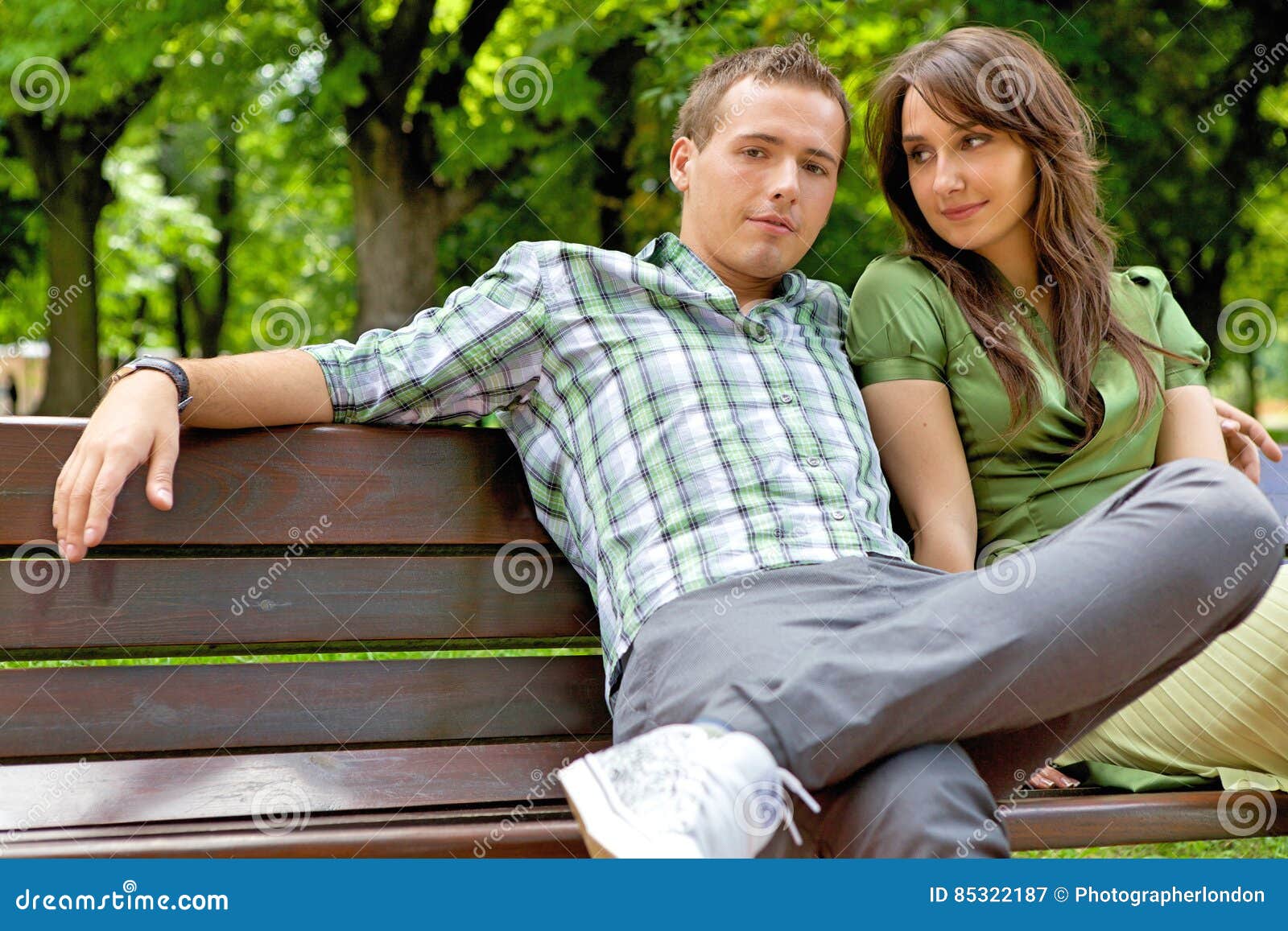Young Couple Sitting on Bench Stock Image - Image of looking, leisure ...
