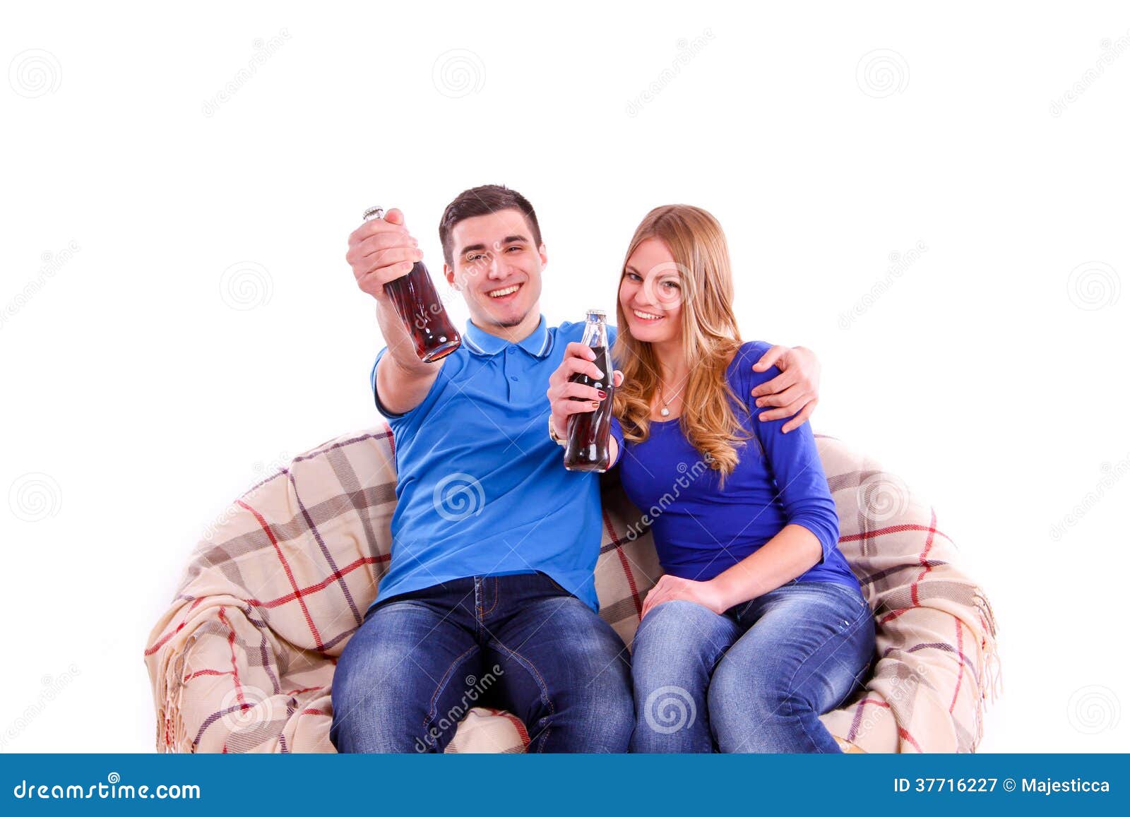 Young Couple Sitting on a Couch and Drinking a Soda Stock Image - Image ...