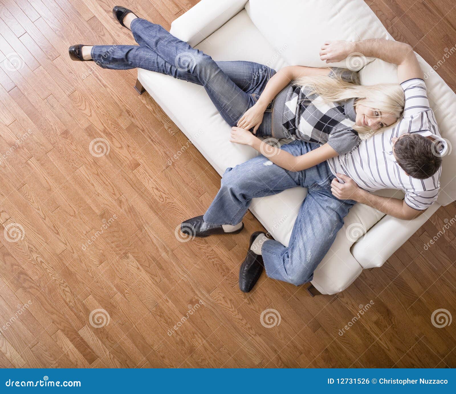 Young Couple Sitting on Love Seat Stock Photo - Image of copy, facing ...